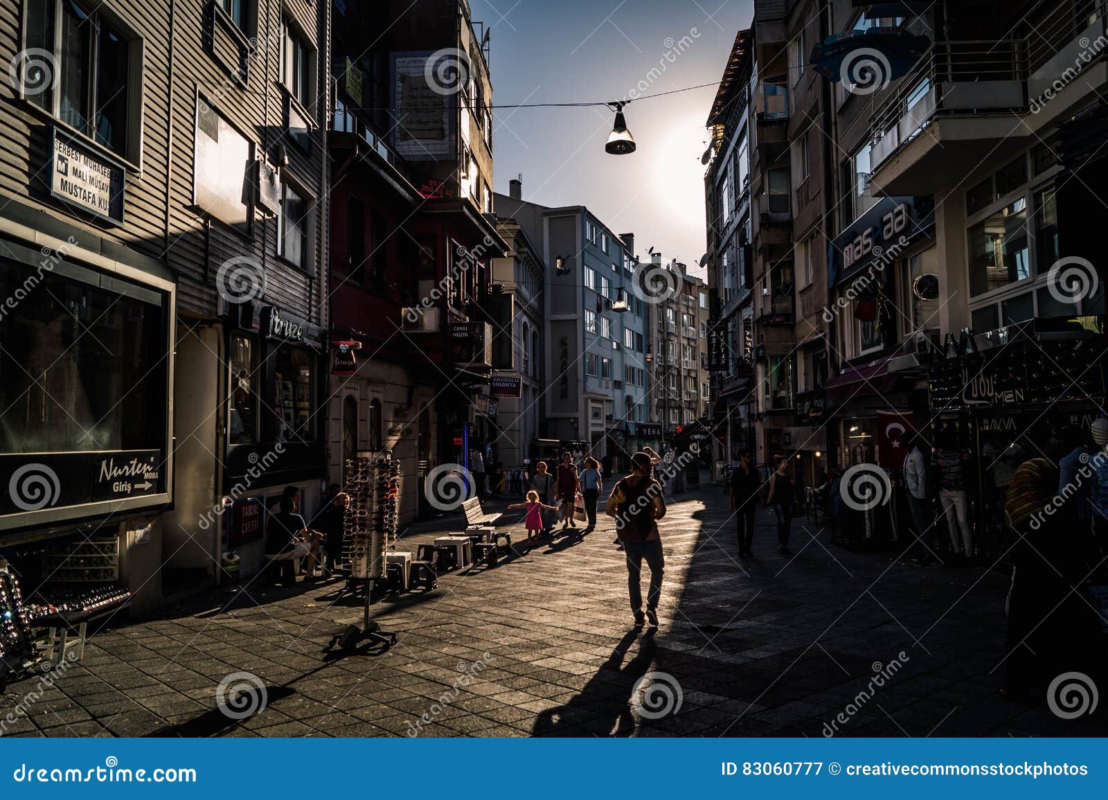 People Walking on Street between High Rise Building Stock Image - Image ...