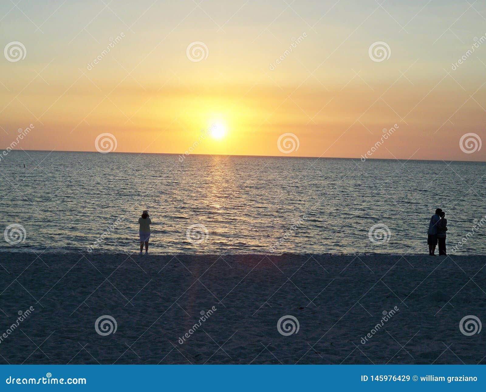 People Watching Sunset on the Beach. Stock Image - Image of coast ...
