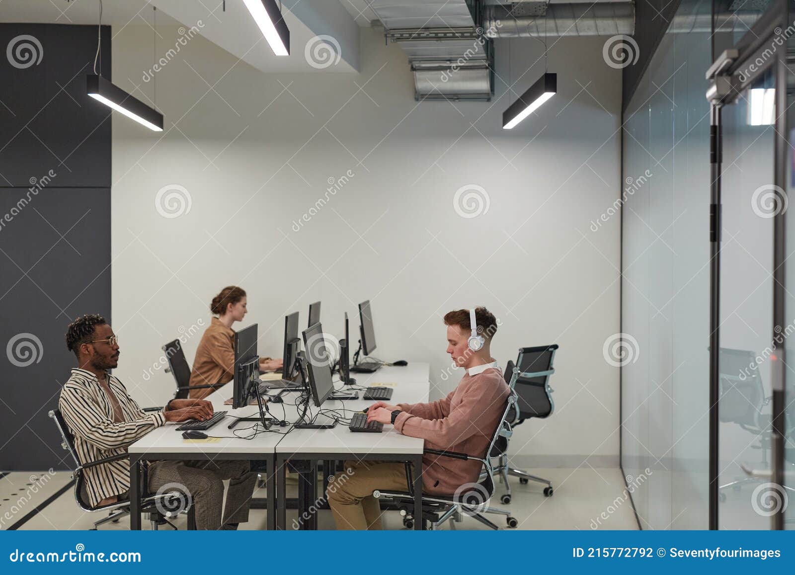 People Working at Computer Desks in Office Stock Photo - Image of code ...