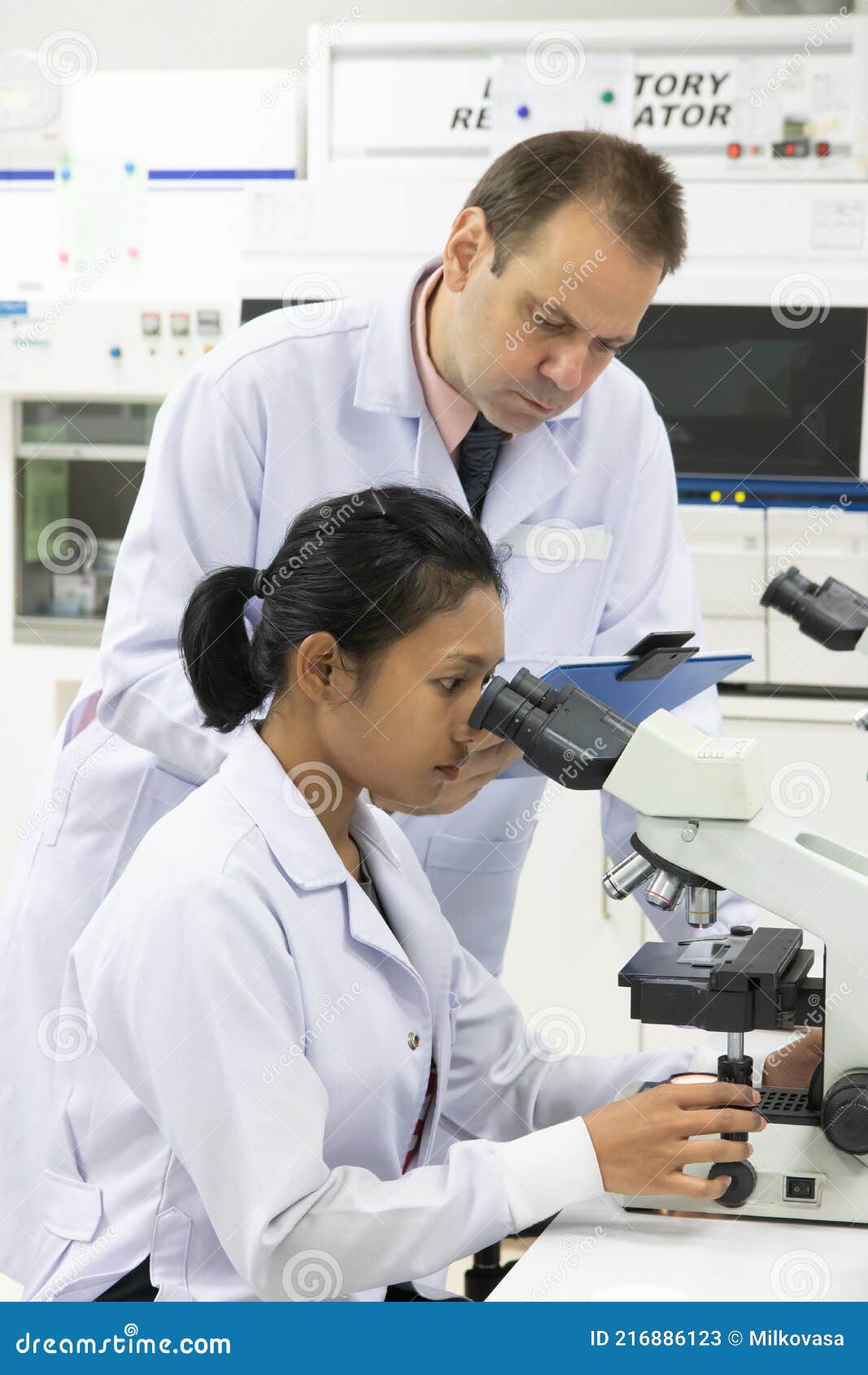 A People Working in a Laboratory with a Microscope Stock Image - Image ...