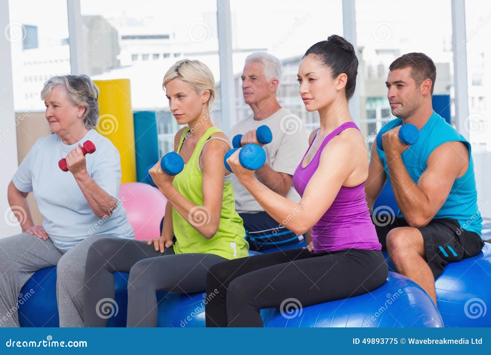 People Working Out with Dumbbells in Gym Class Stock Image - Image of ...