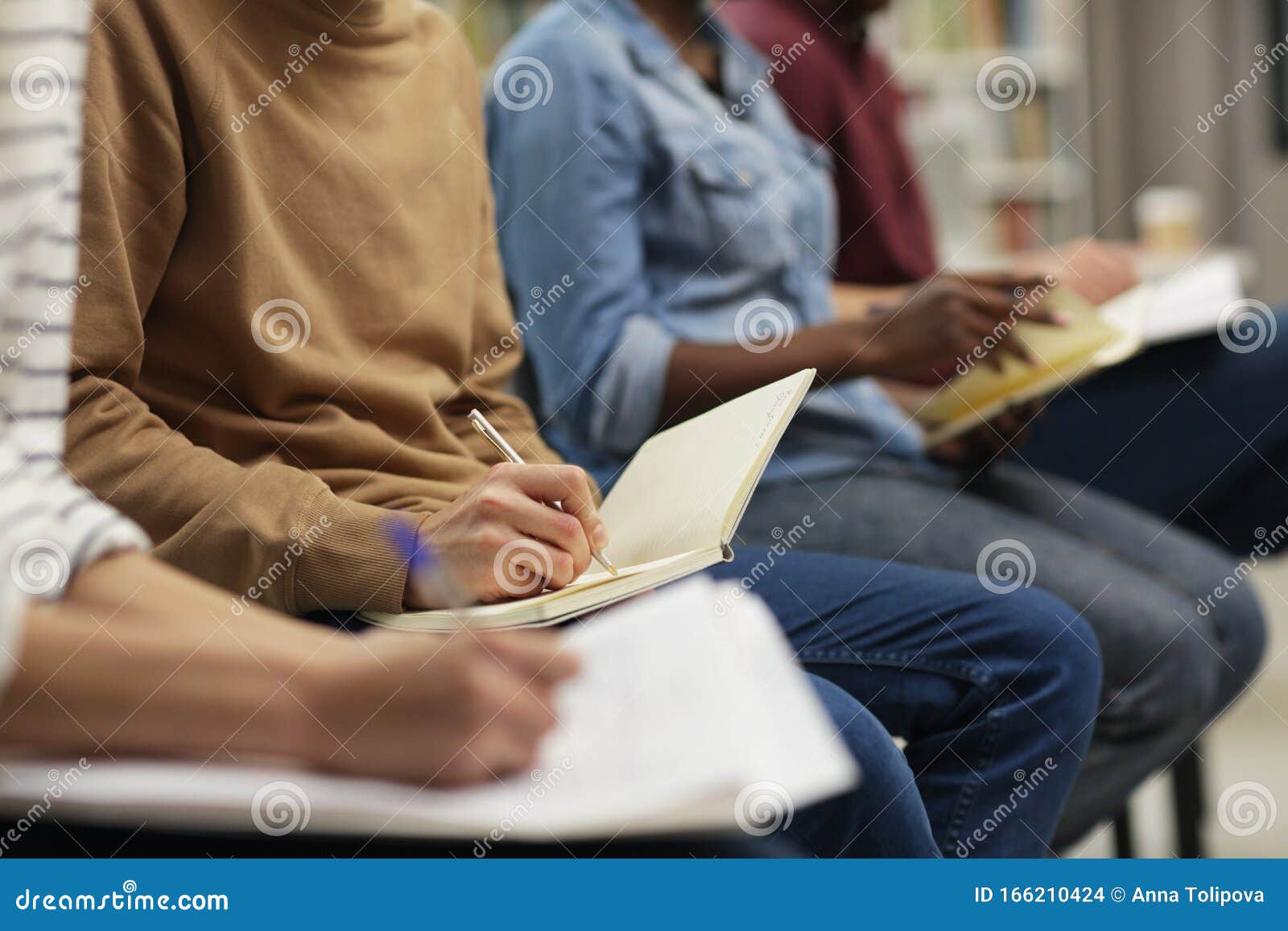 People writing at seminar stock photo. Image of document - 166210424