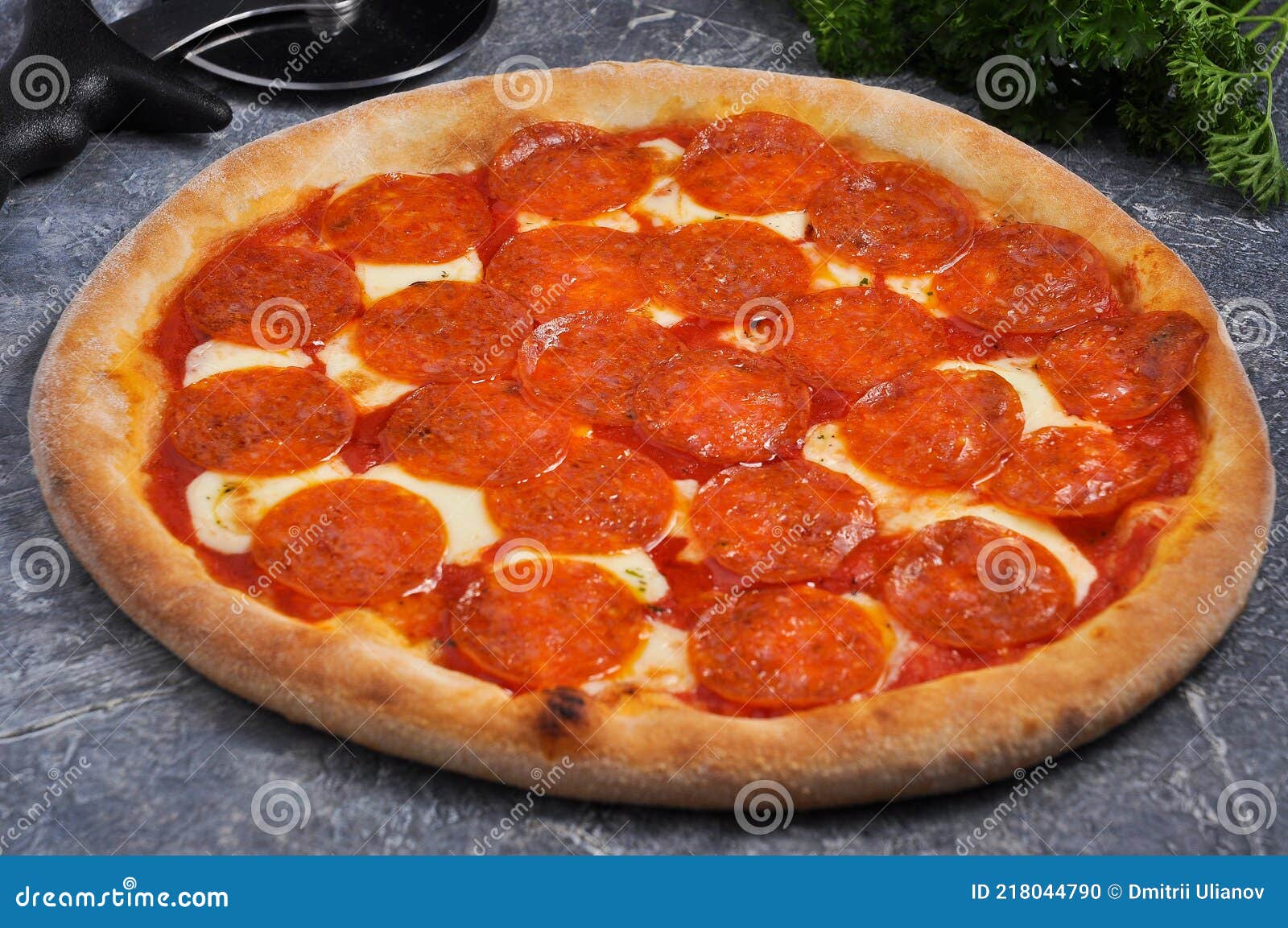 Pepperoni Pizza on a Gray Background Decorated with Greenery Stock ...