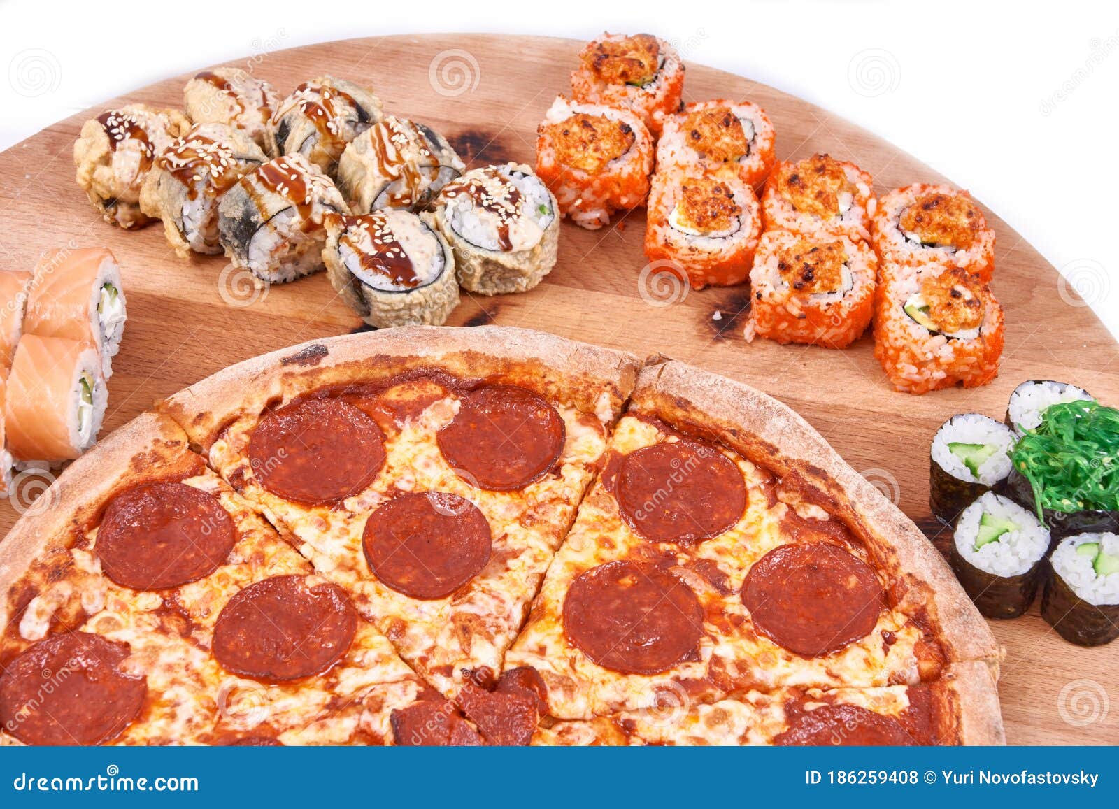 Pepperoni Pizza with Sushi Rolls Set on Wood Stock Photo - Image of ...