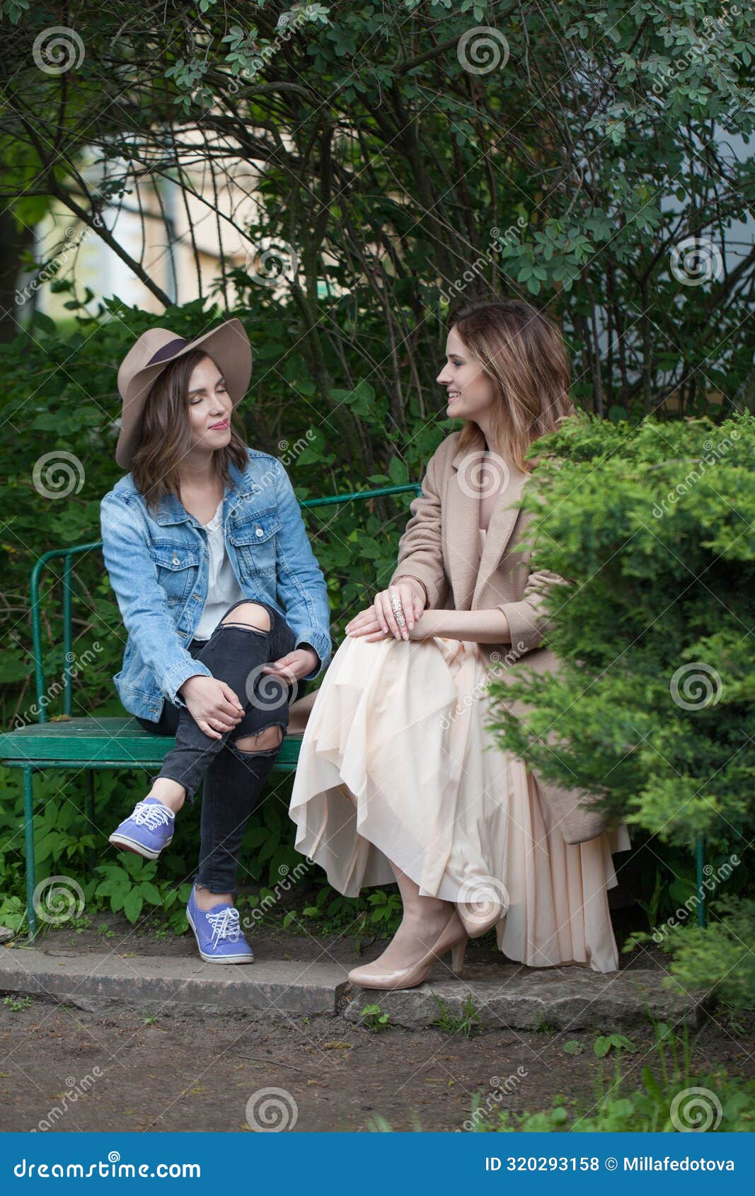 Perfect Friends Talking and Sitting on a Park Bench Outdoors Stock ...