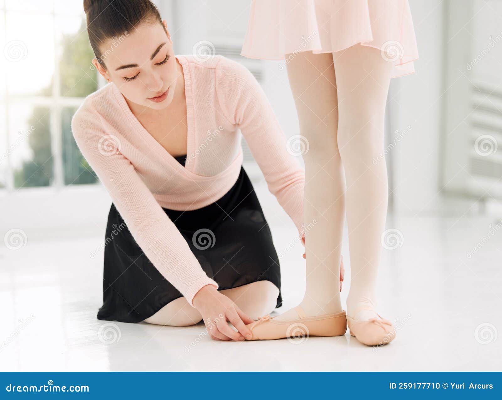 Perfecting Her Art. a Ballet Teacher Assisting a Student with Her ...