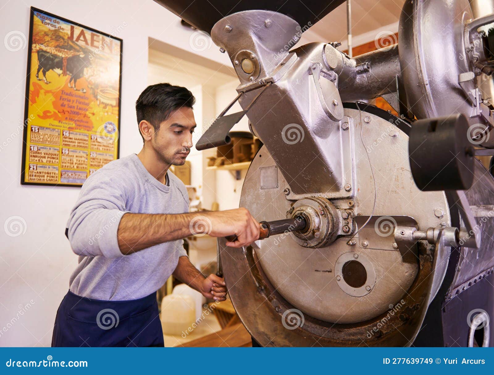 Perfecting His Roasting Process. a Machine Grinding and Roasting Coffee ...