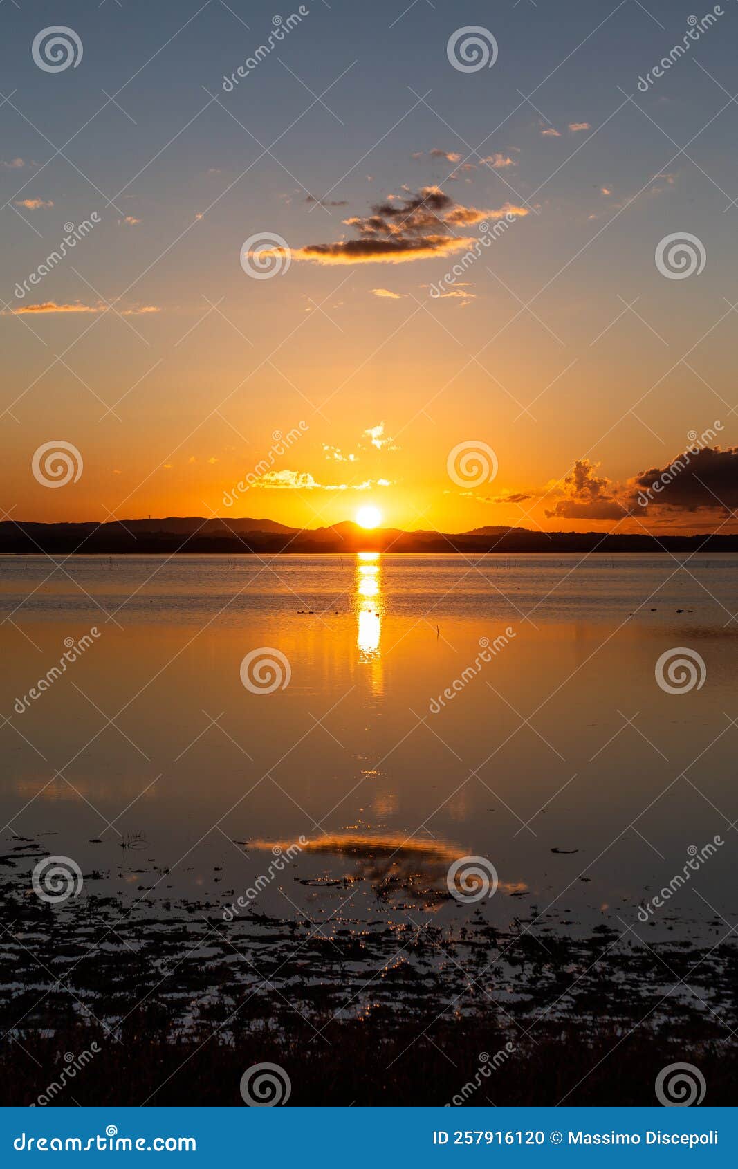 Perfectly Symmetric Clouds and and Sun Reflections on a Lake at Sunset ...