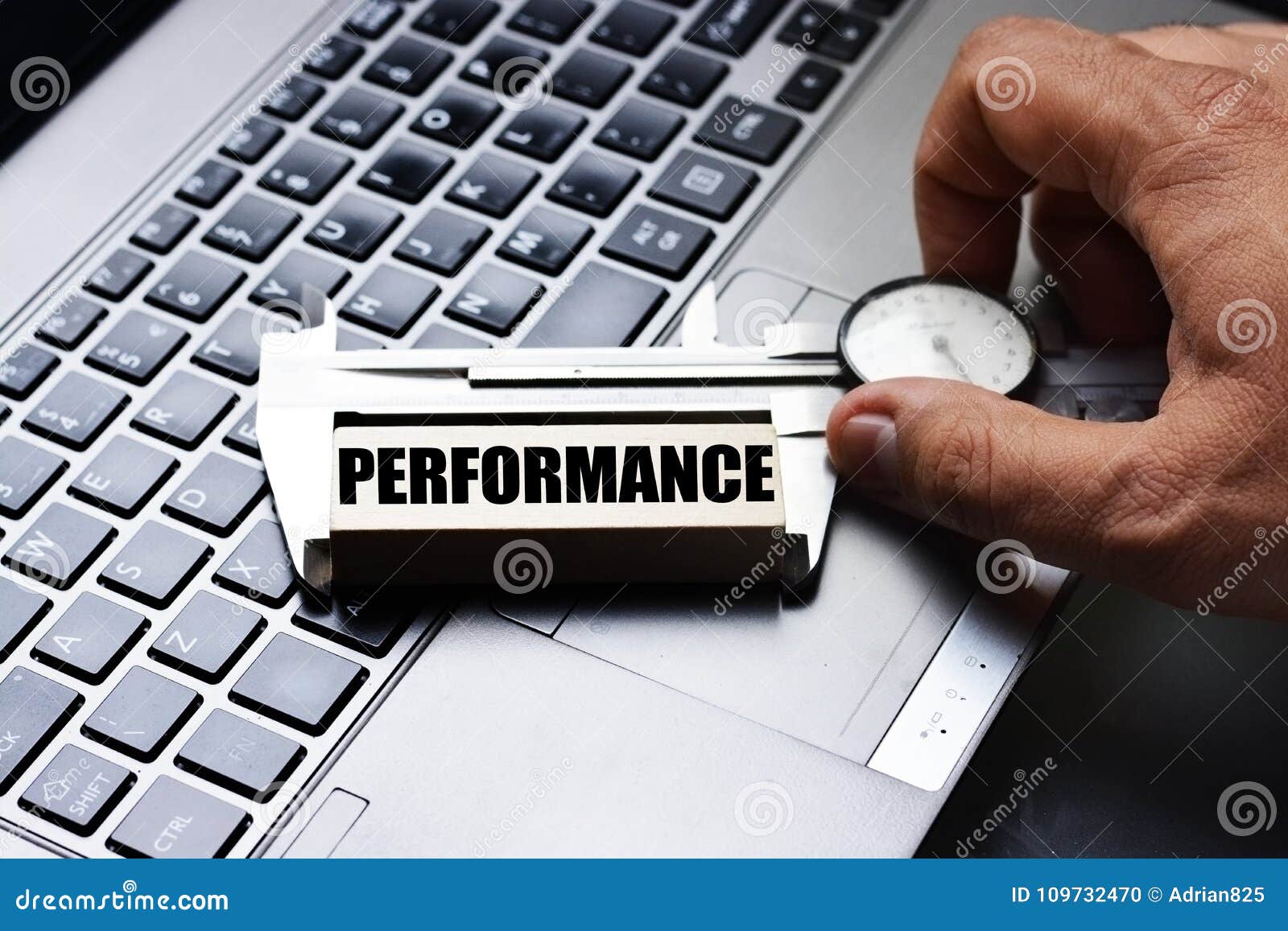 Man Hand Measuring Performance with Caliper Tool on Notebook Keyboard ...
