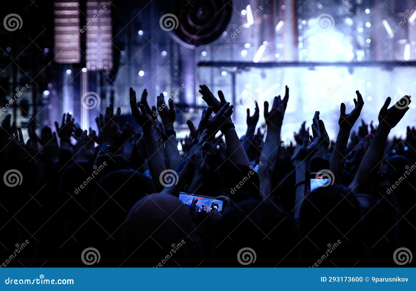Performance of a Popular Group. the Crowd with Raised Hands Against the ...
