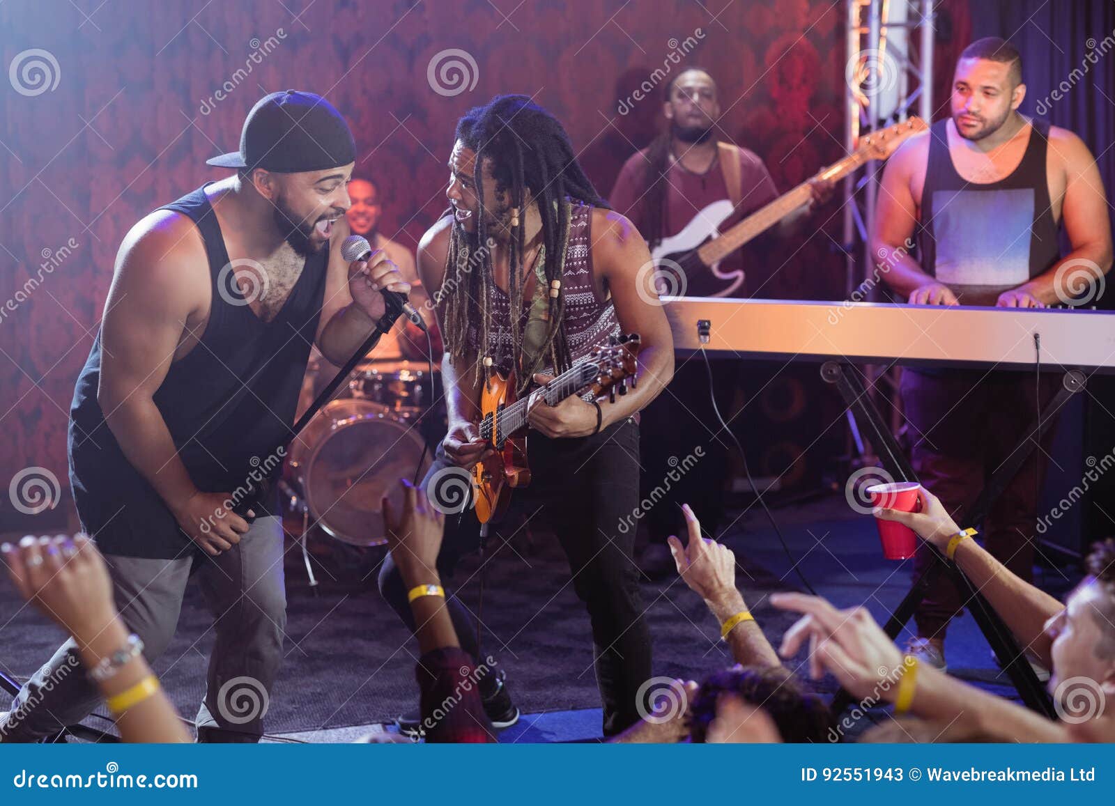 Performers Singing at Nightclub Stock Image - Image of group, arms ...