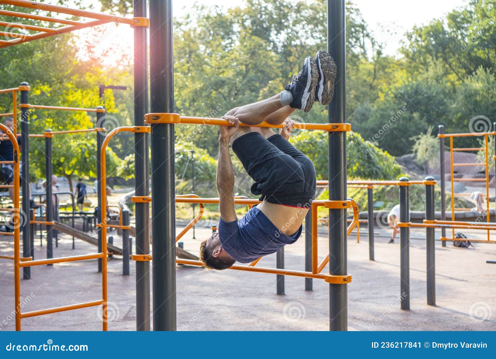 Performing Acrobatic Exercises on the Horizontal Bar. Stock Image ...