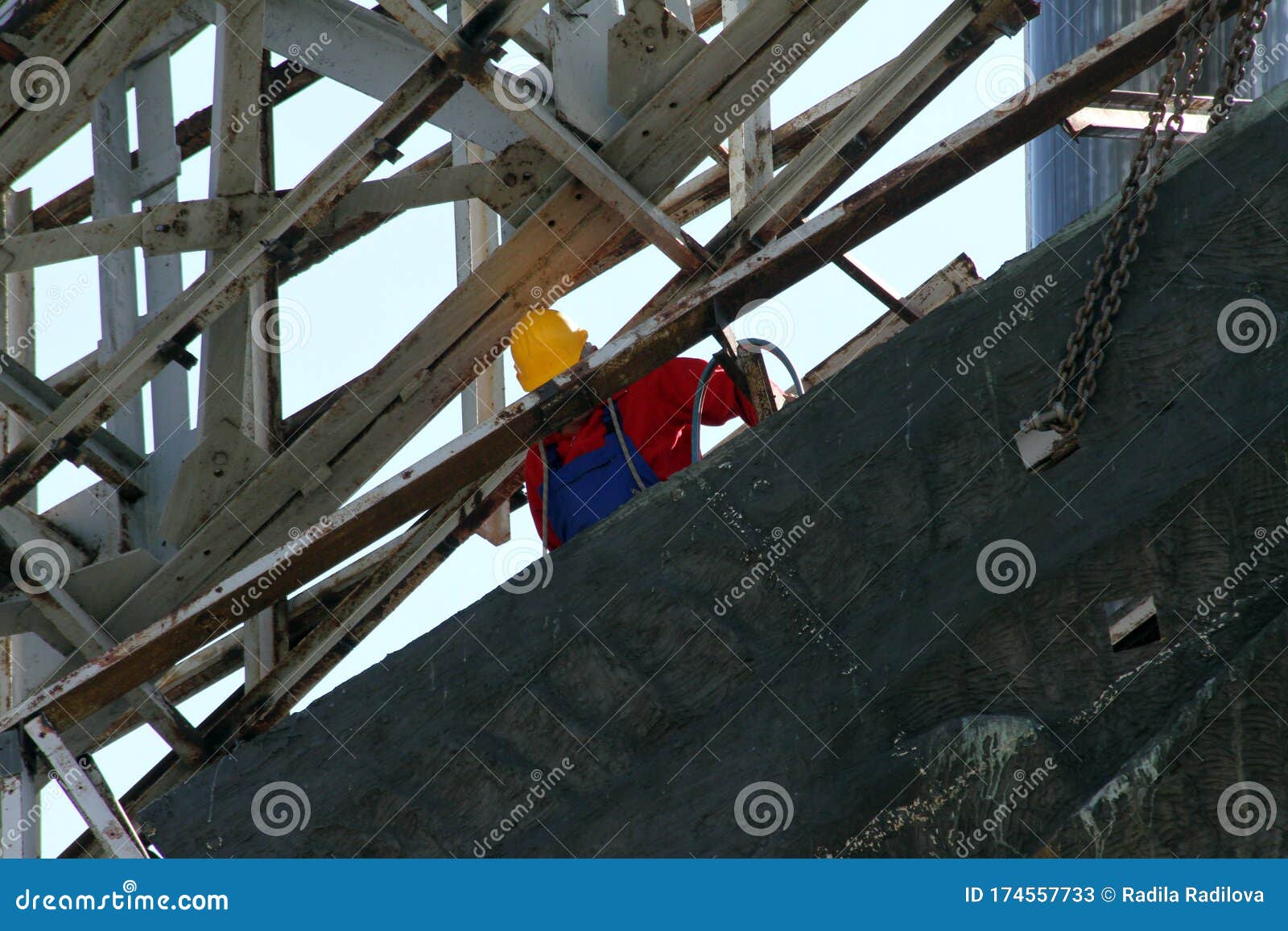 Performing Heavy Construction Work. a Worker Climbs in Height and ...