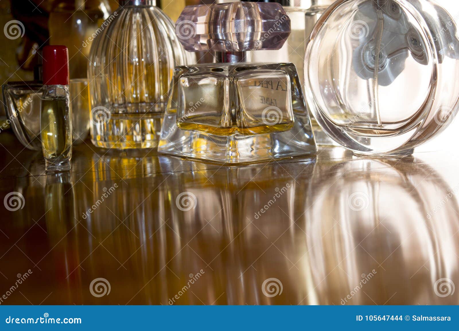 Perfume bottle in back-lit stock photo. Image of back - 105647444