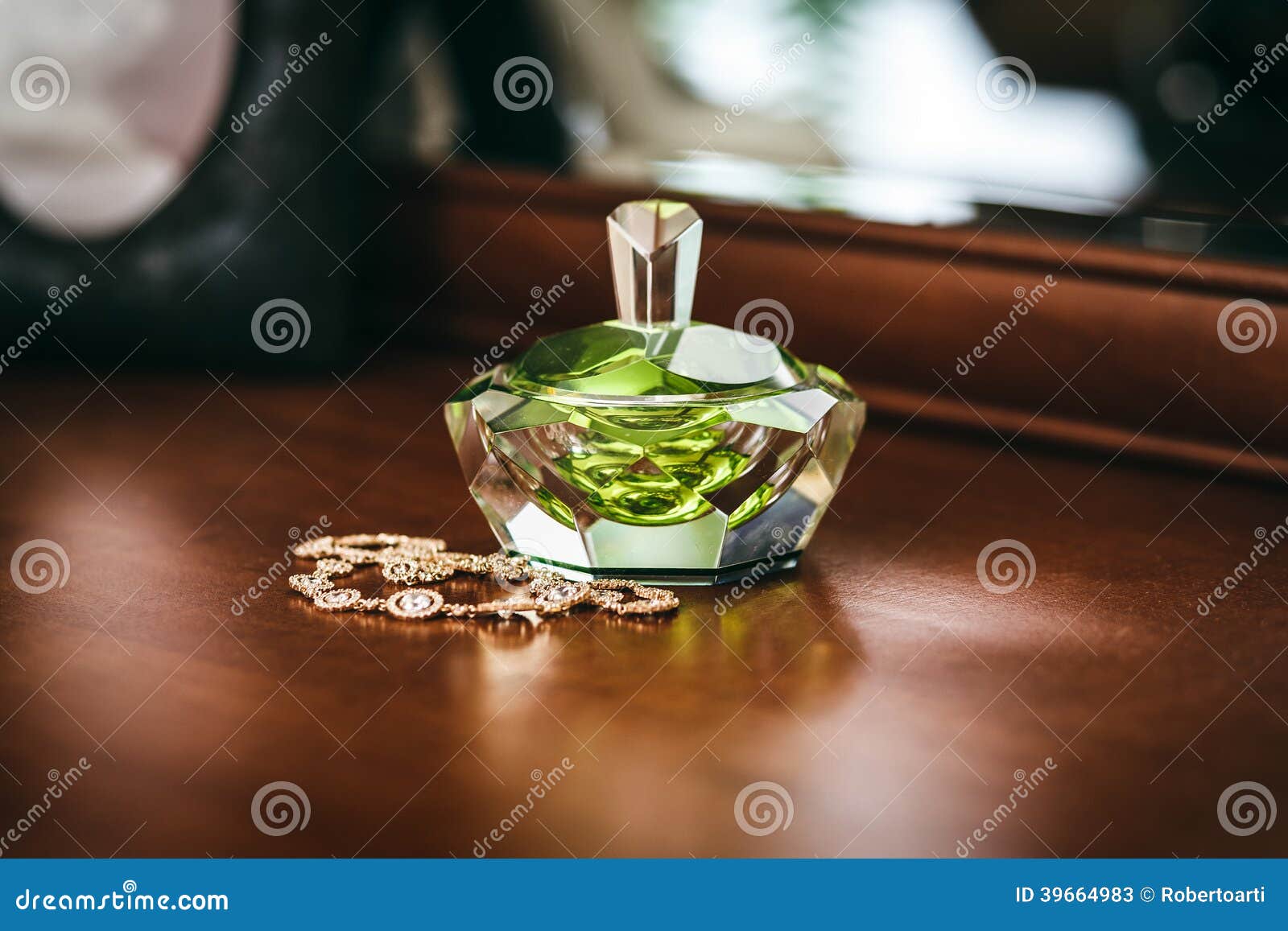 Perfume Bottle with a Beautiful Green Ruby Shine and Jewelry on Stock ...