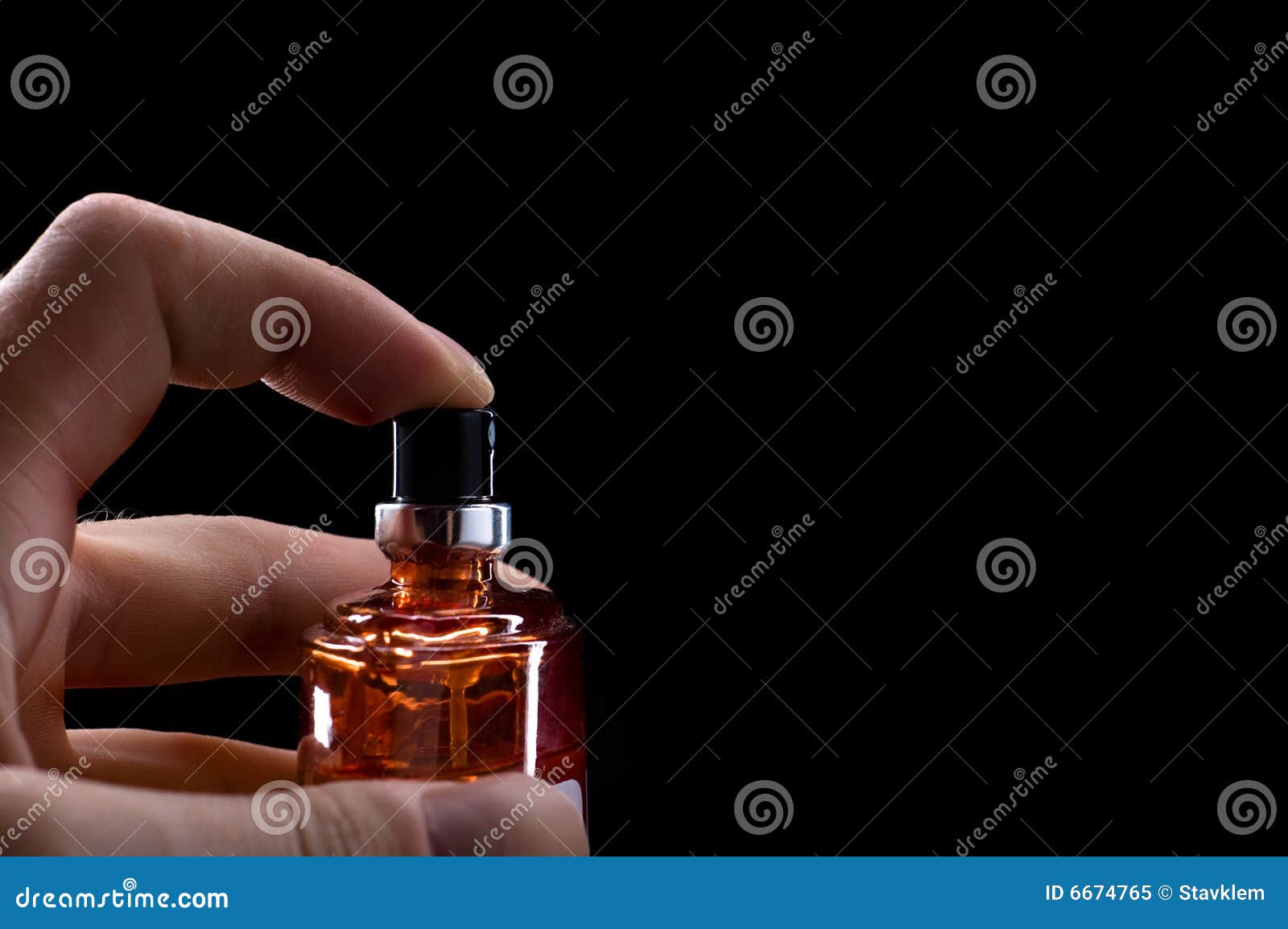 Perfume Bottle in Hand Isolated on Black Stock Image - Image of ...