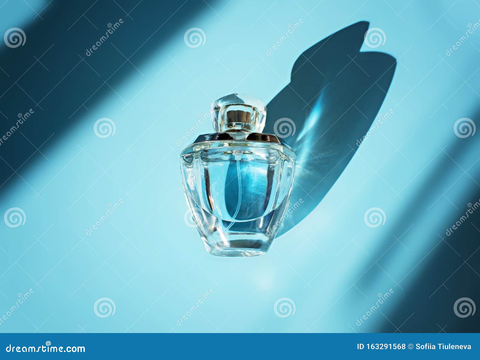 Perfume Bottle on Light Blue Background Stock Photo - Image of light ...