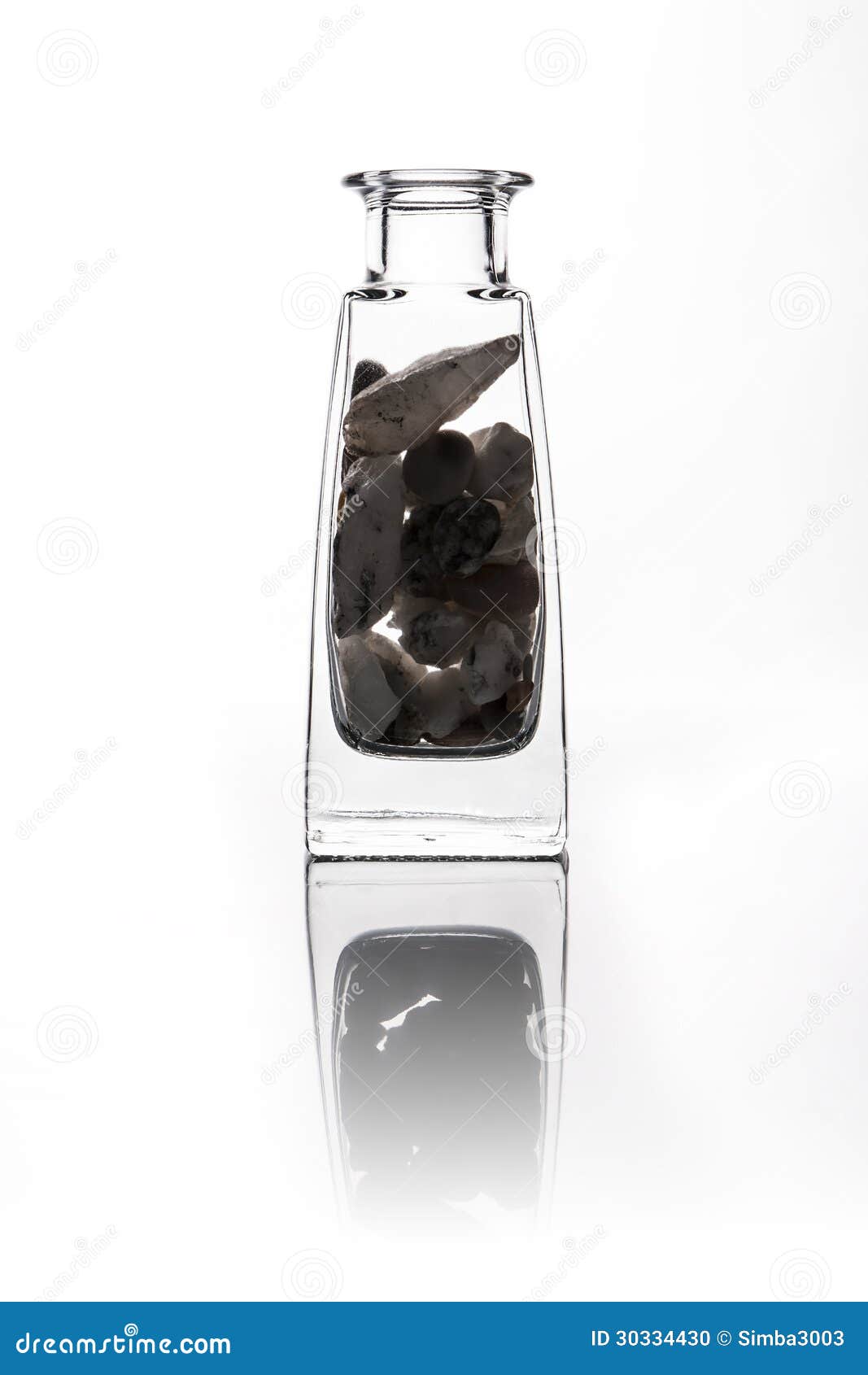 Perfume Bottle with Little Stones Inside Reflected on White Stock Photo ...