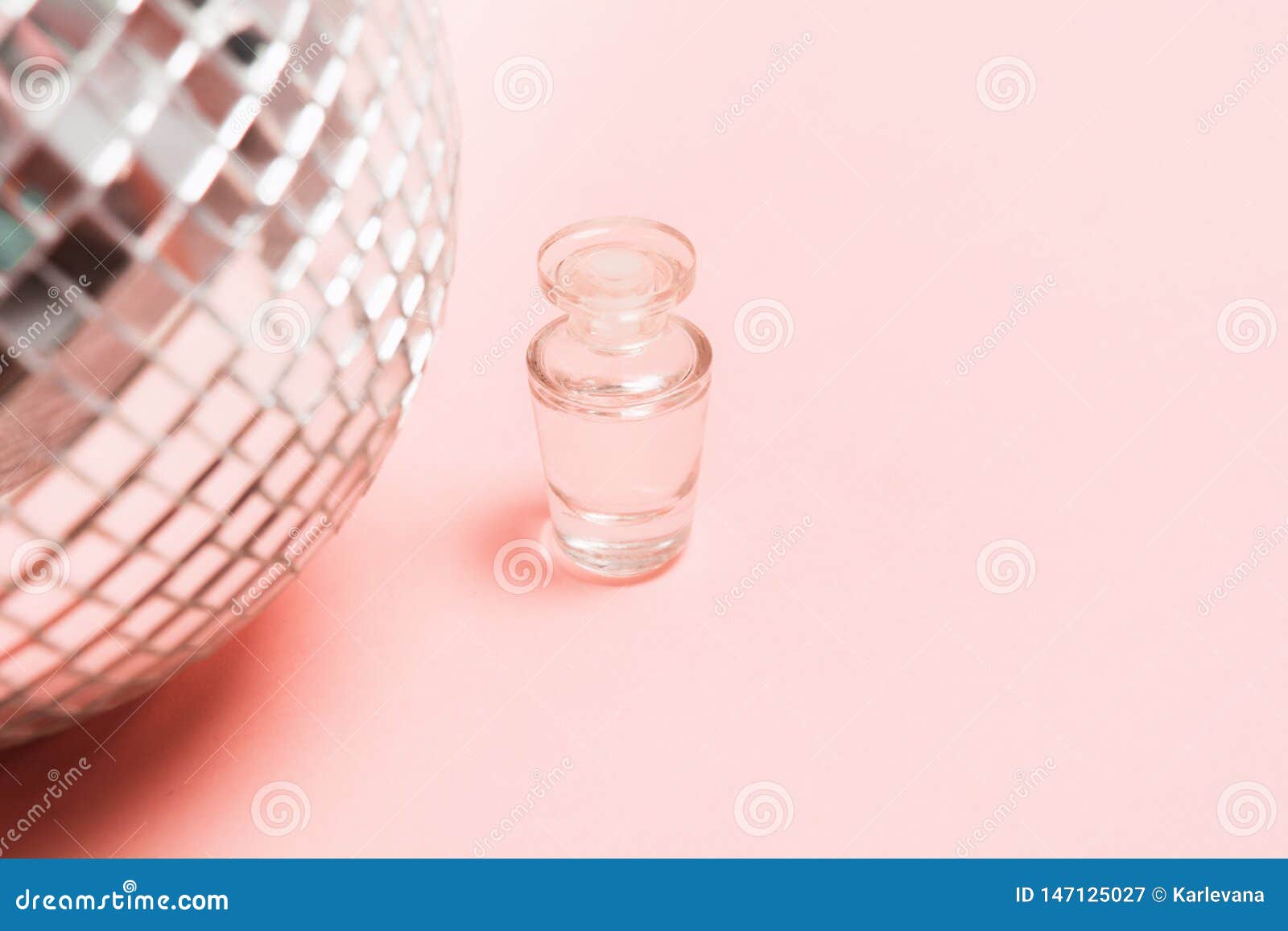 Perfume Bottle on Pink Background with Disco Ball. Copy Space Stock ...