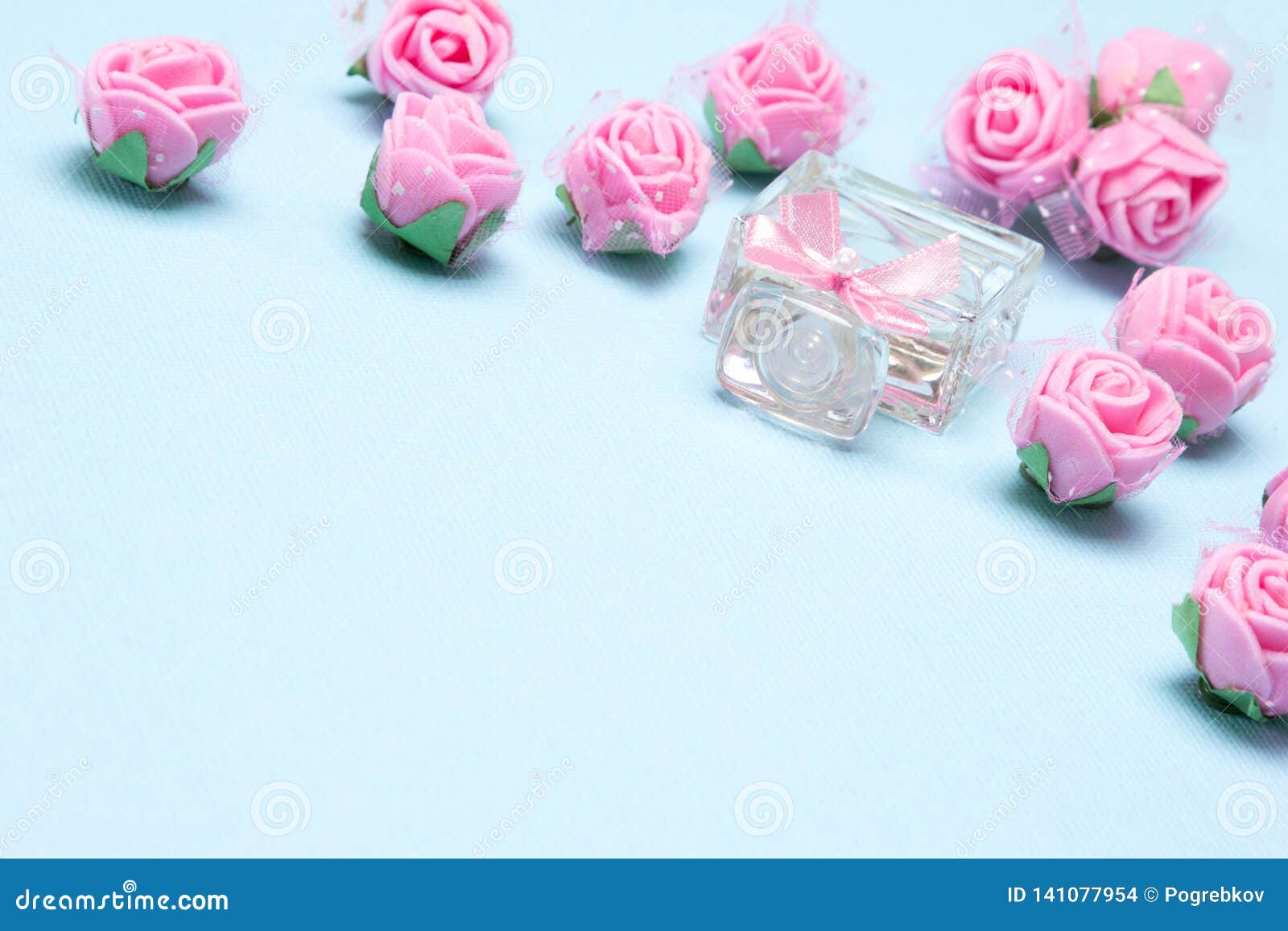 Perfume Bottle with Small Pink Roses and Bow Stock Photo - Image of ...