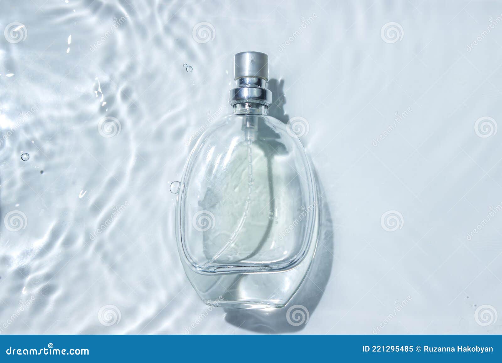 Perfume Bottle on the Surface of the Water. Circle Ripples on Water ...