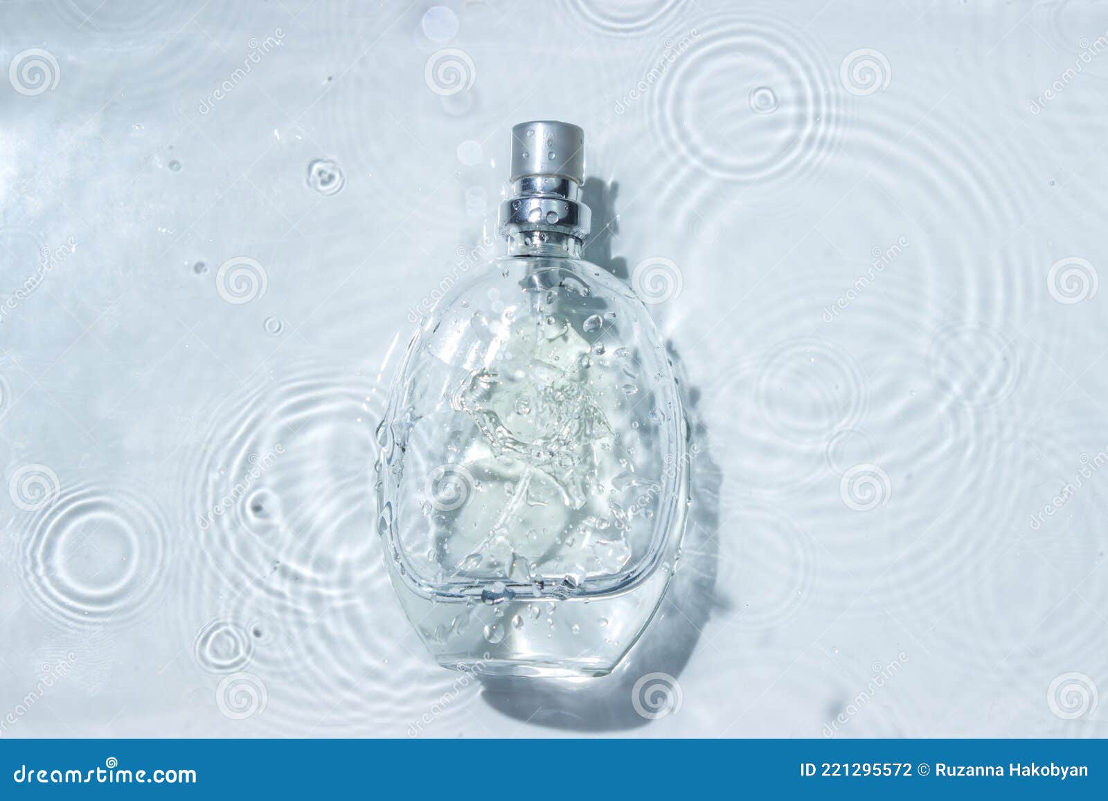 Perfume Bottle on the Surface of the Water. Circle Ripples on Water ...