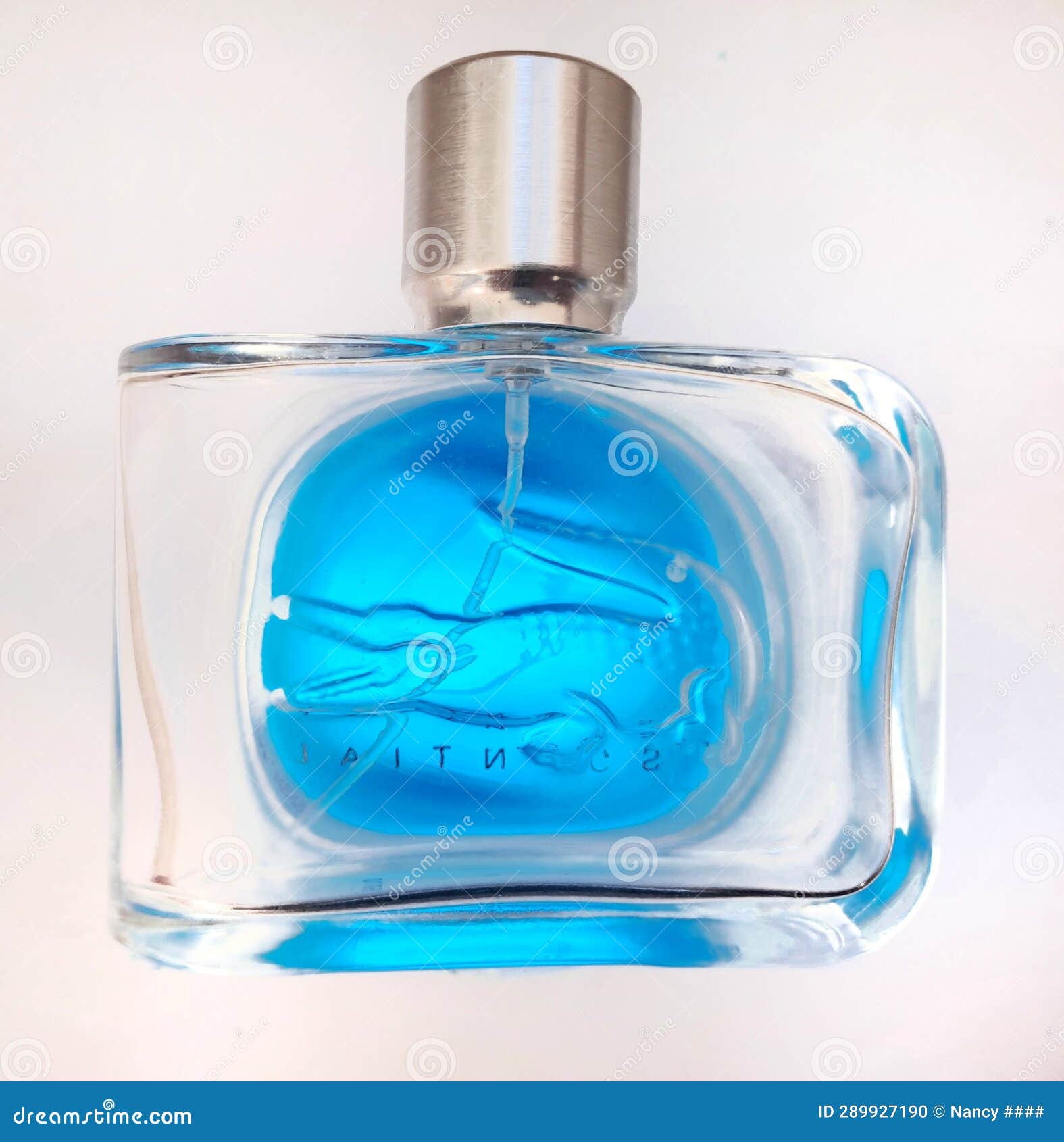 A Perfume with a Picture of a Crocodile and Blue Highlights on a White ...