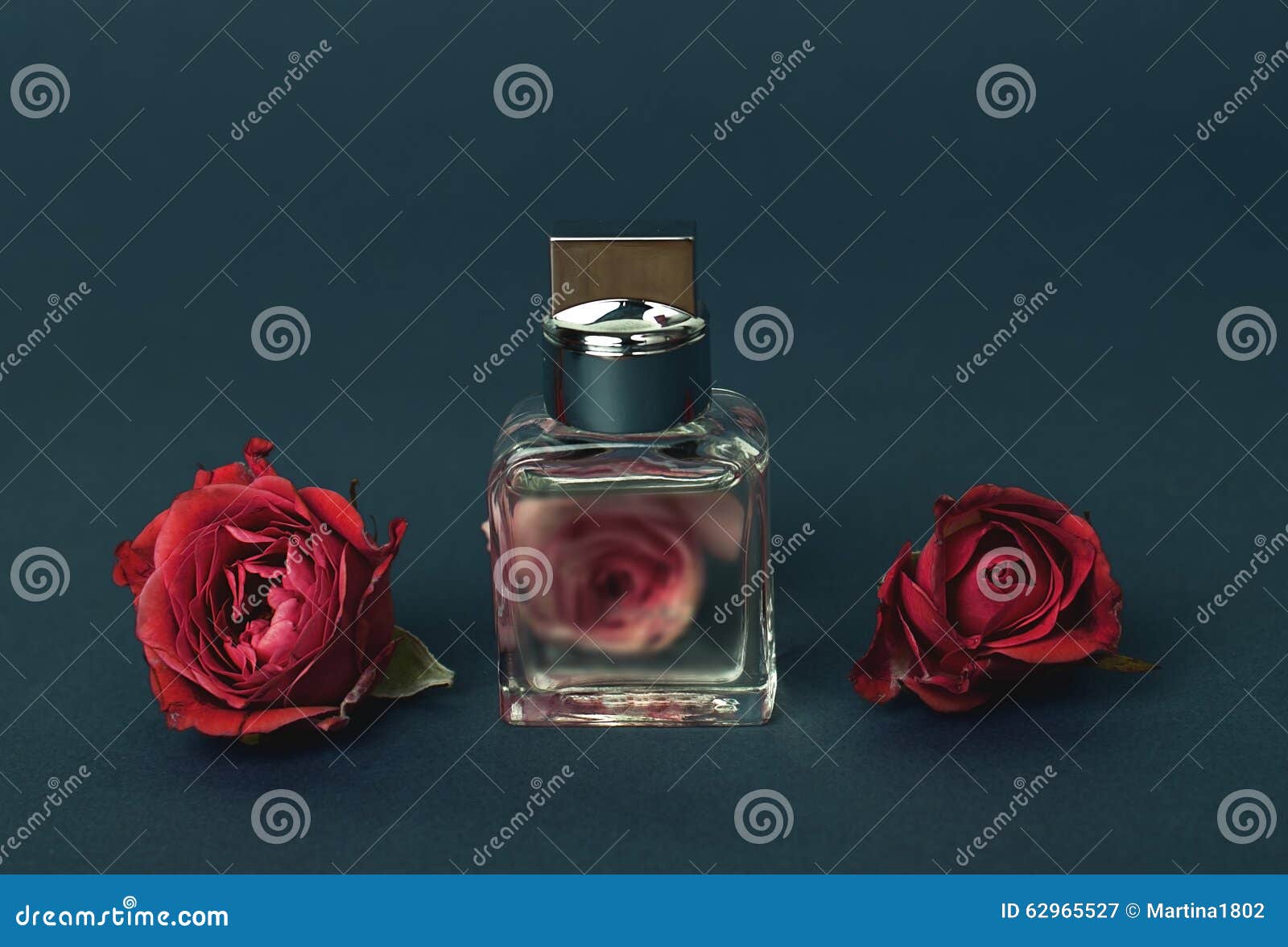 Perfume and red flowers stock image. Image of female - 62965527