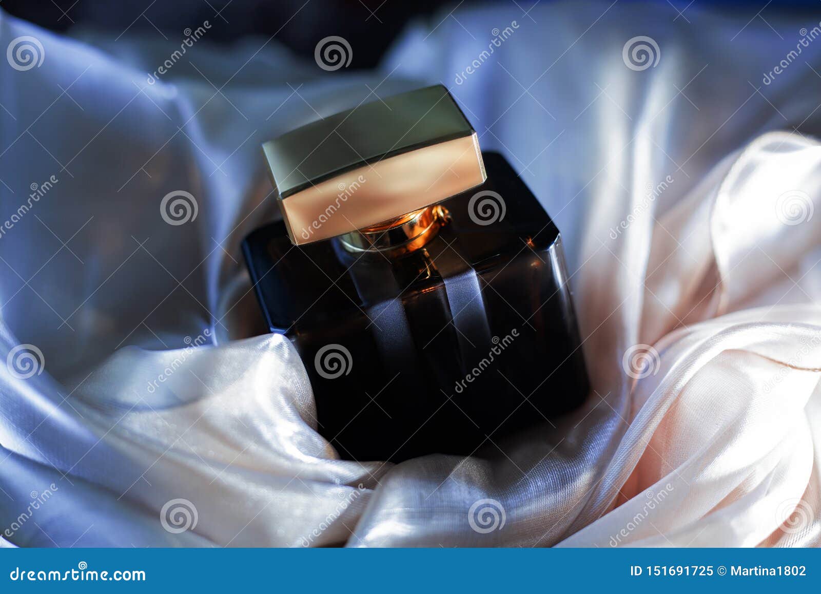 Perfume on silk fabric stock image. Image of shiny, material - 151691725