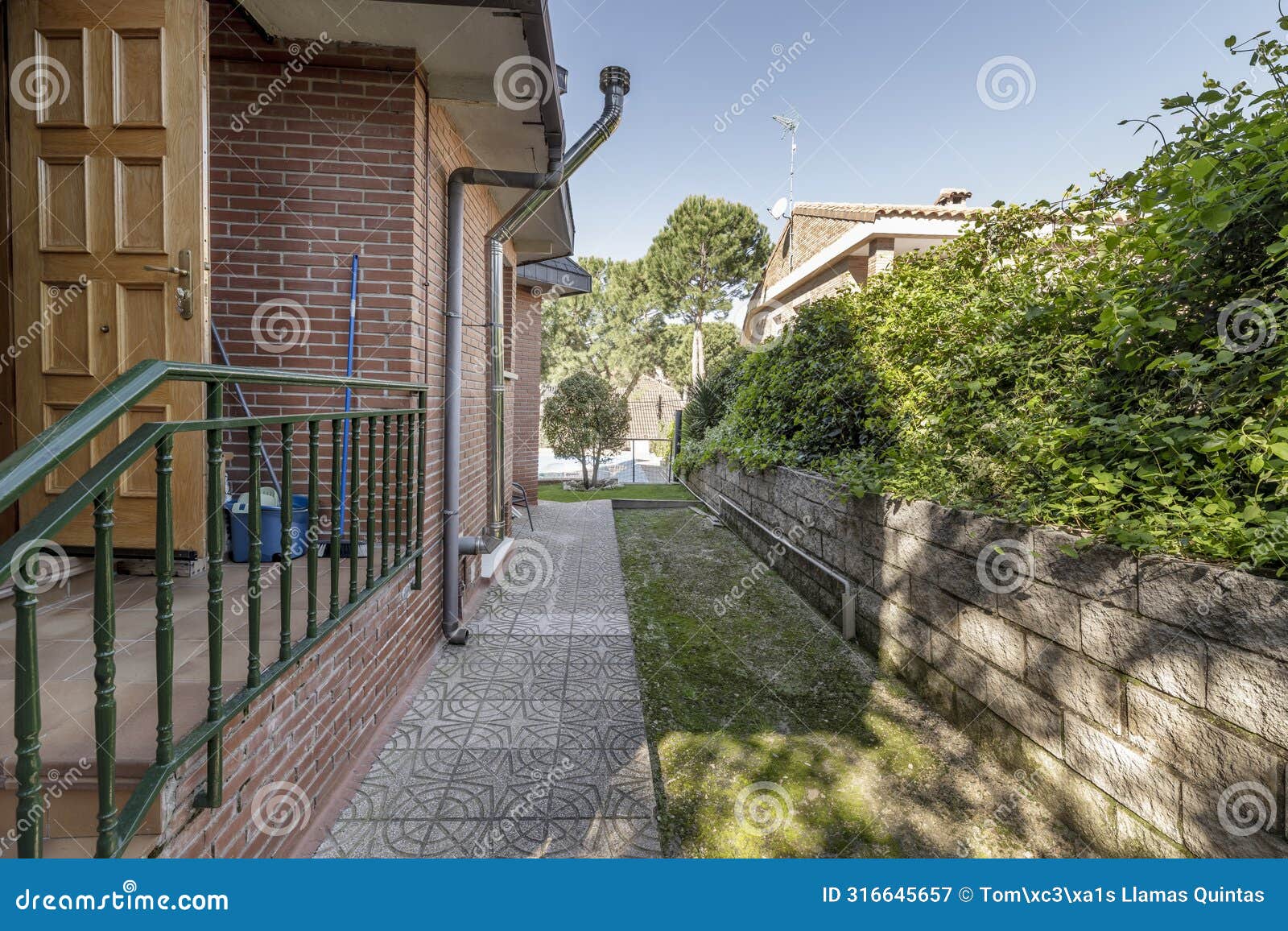 Perimeter Garden with a Tiled Path Around a Detached House with Brick ...