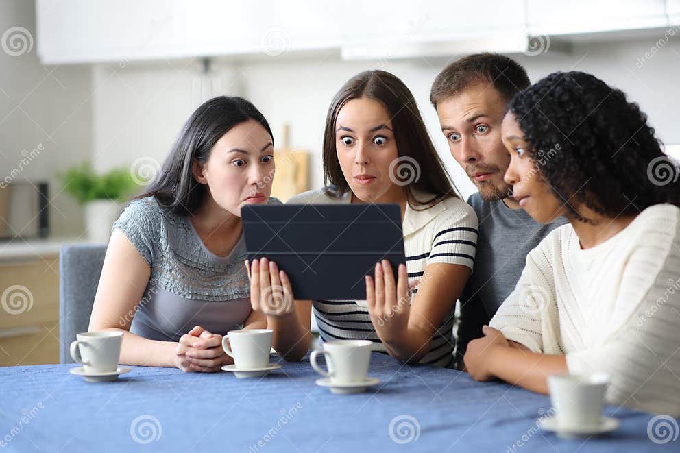 Perplexed Group of Friends Checking Tablet Stock Photo - Image of home ...