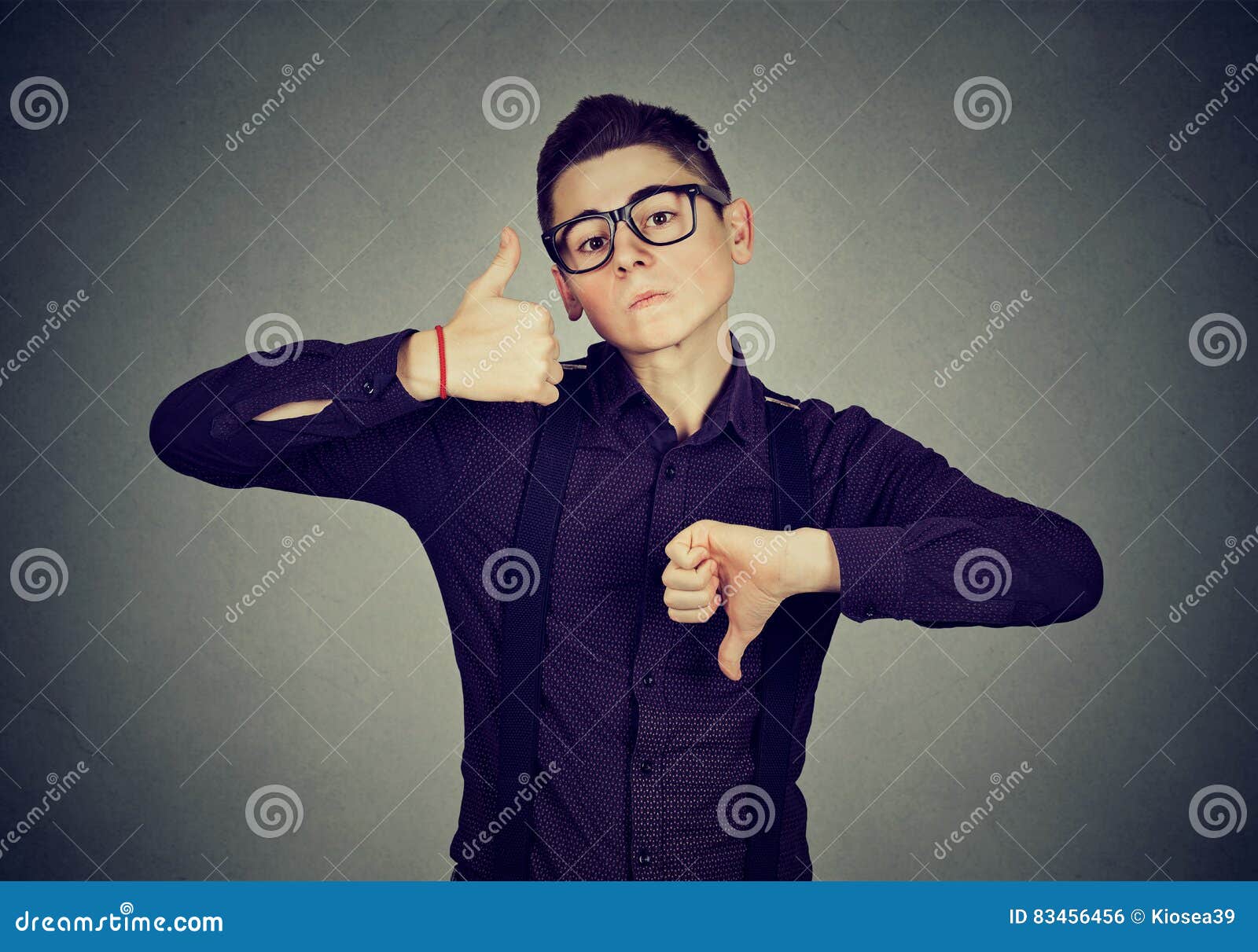 Perplexed Man with Thumbs Down Thumbs Up Gesture Stock Photo - Image of ...