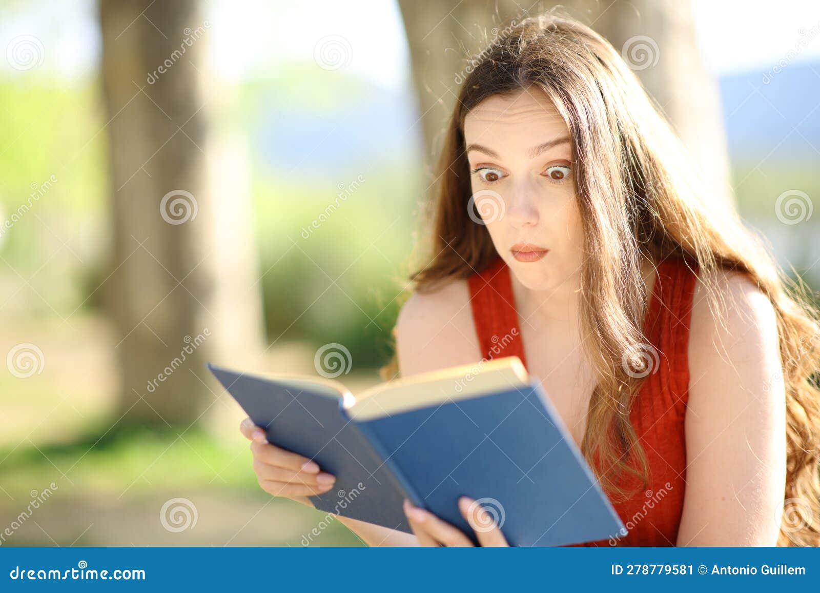 Perplexed Reader Reading a Paper Book Outdoors Stock Image - Image of ...