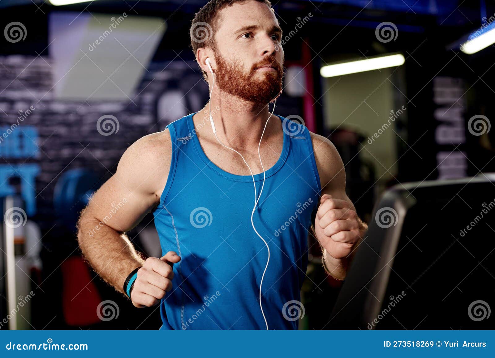 Perseverance Pays Off. a Young Man Working Out on a Treadmill at the ...