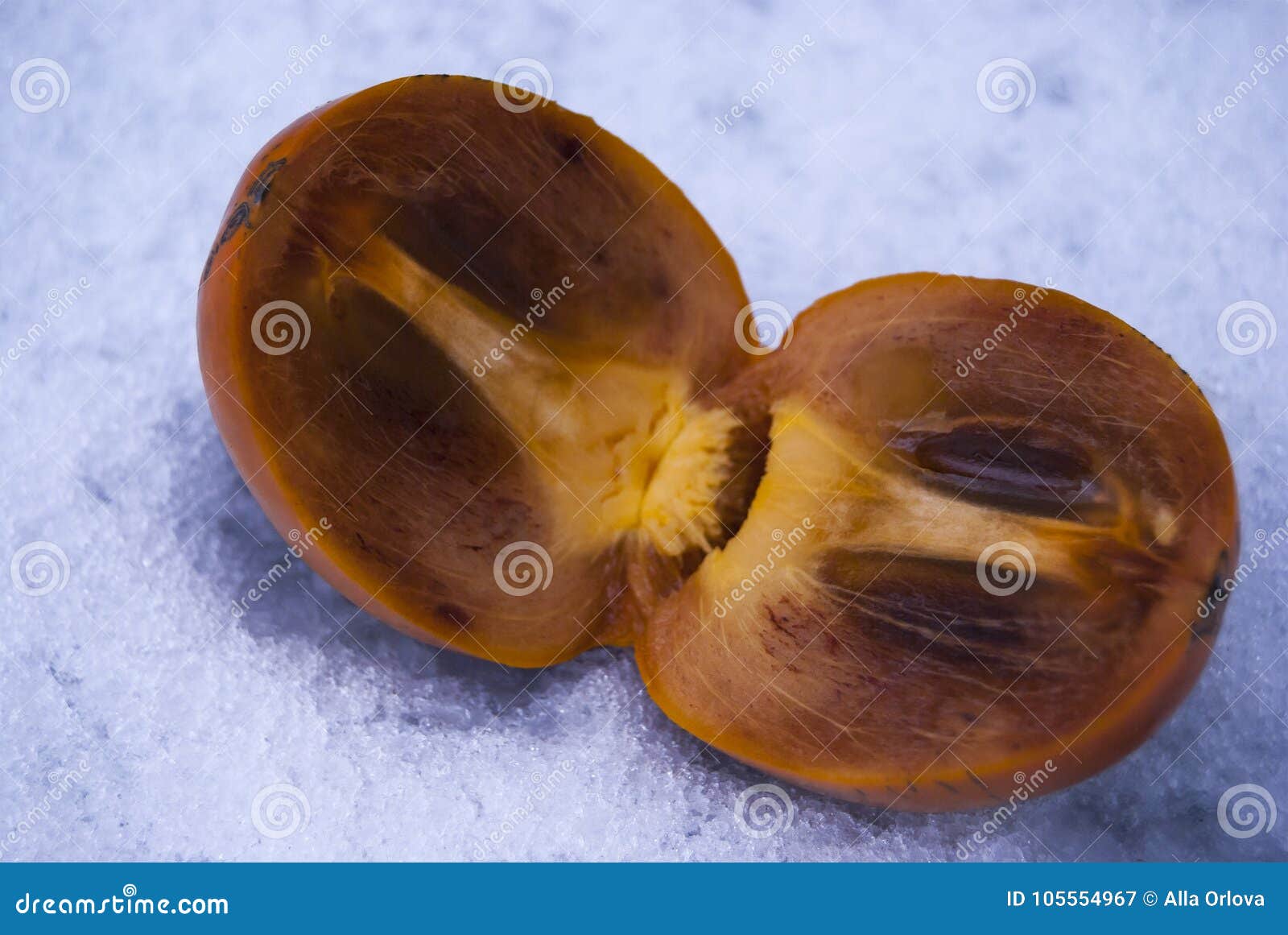 Persimmon, Cut in Half, Lies on the Snow Stock Image - Image of ...
