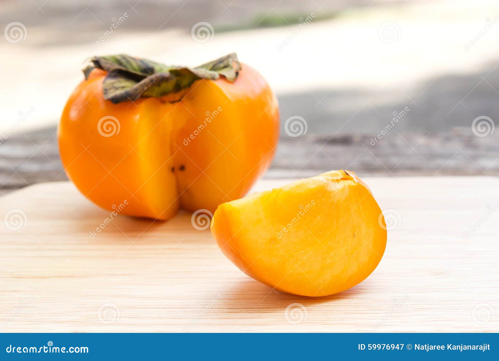 Persimmon on wood board. stock image. Image of harvest - 59976947