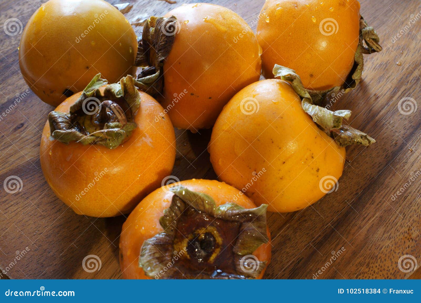 Persimmons on the table stock photo. Image of persimmons - 102518384