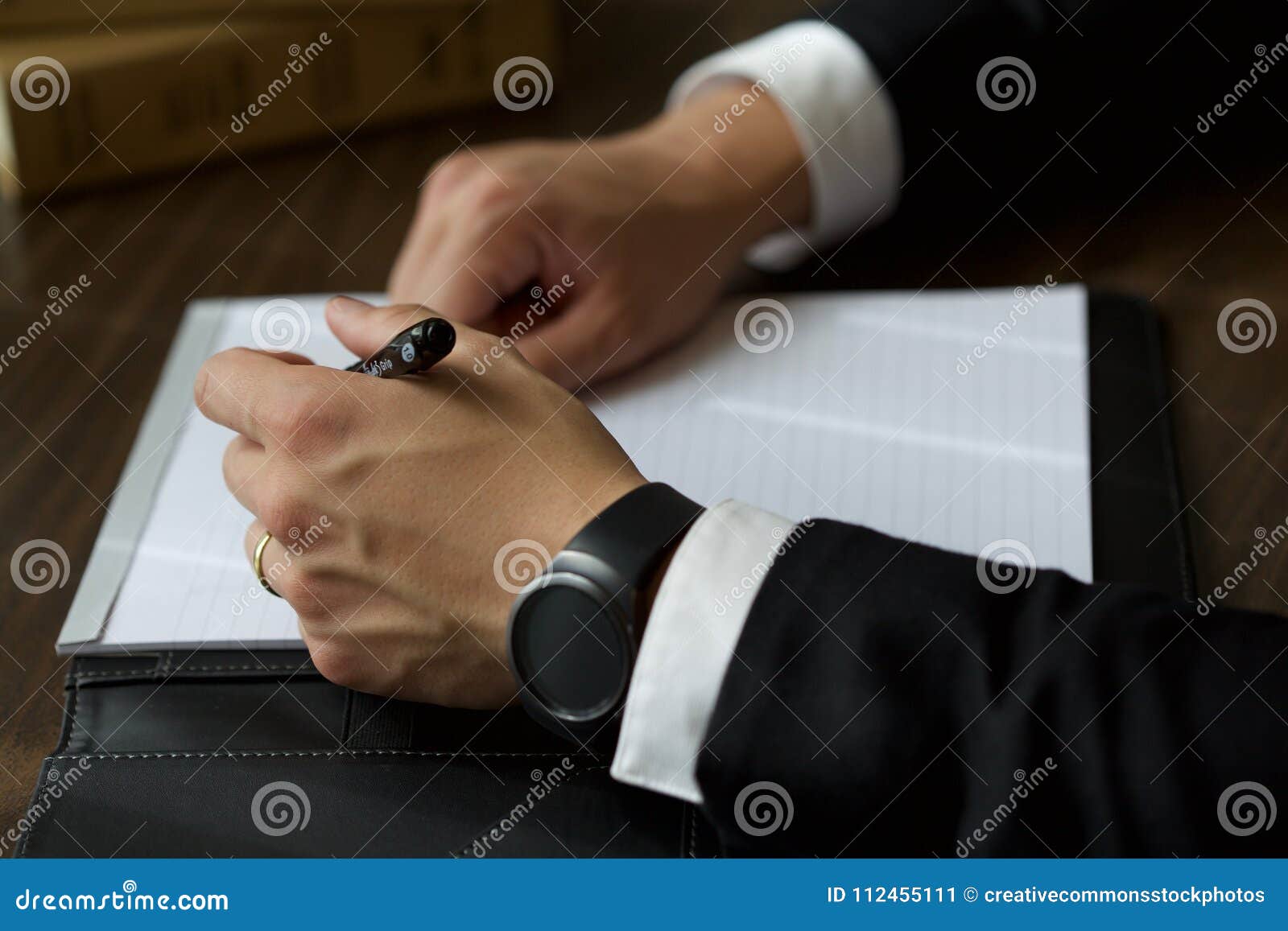 Person On Black Suit Jacket Writing On White Paper Picture. Image ...