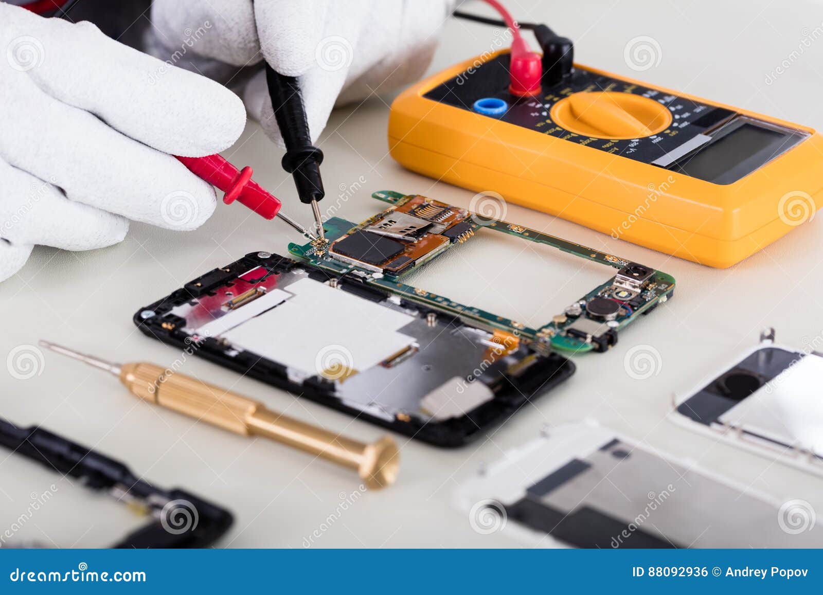 Person Checking Mobile Phone with Digital Multimeter Stock Photo ...