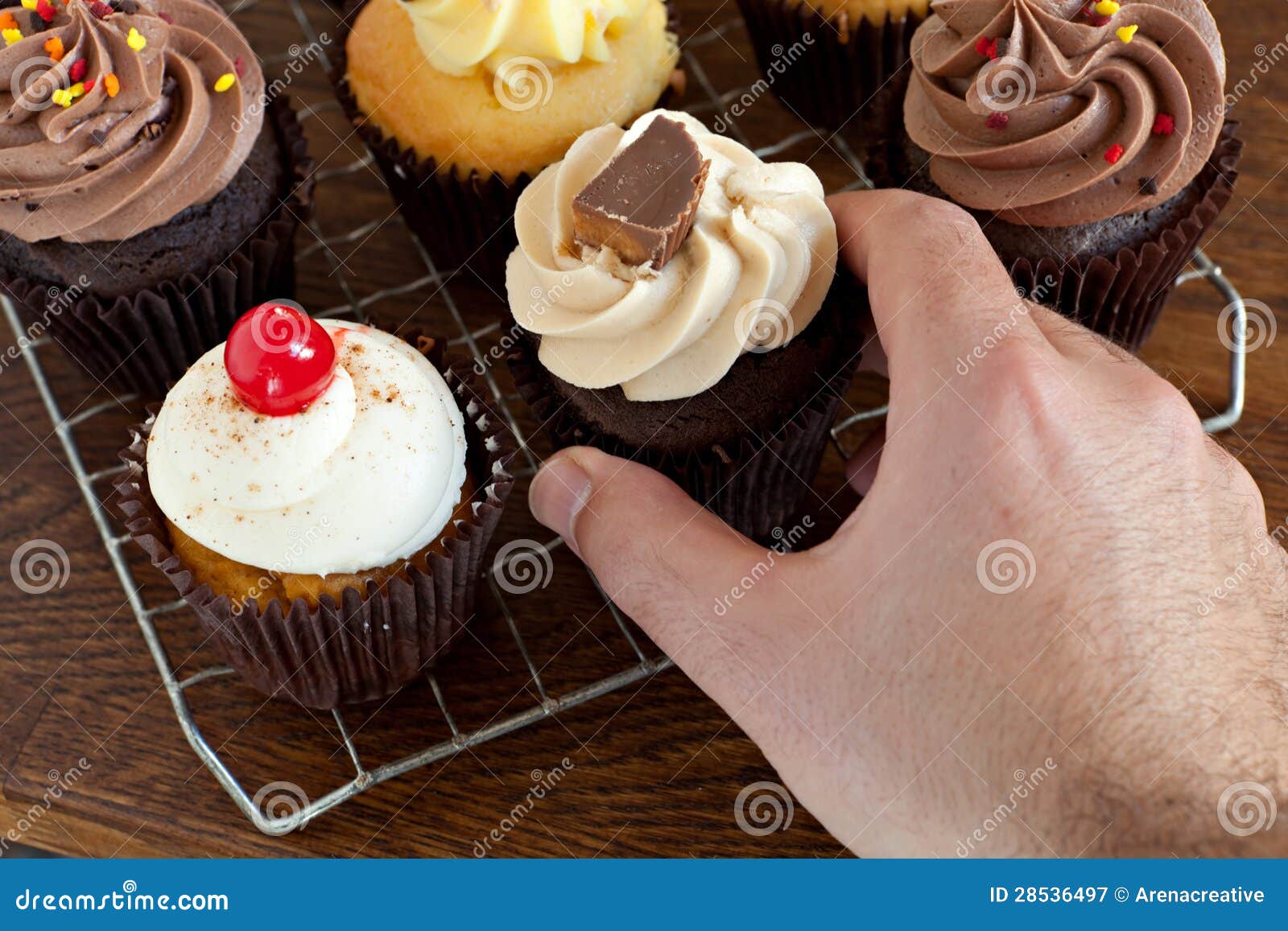Person Choosing a Cupcake stock image. Image of bakery - 28536497
