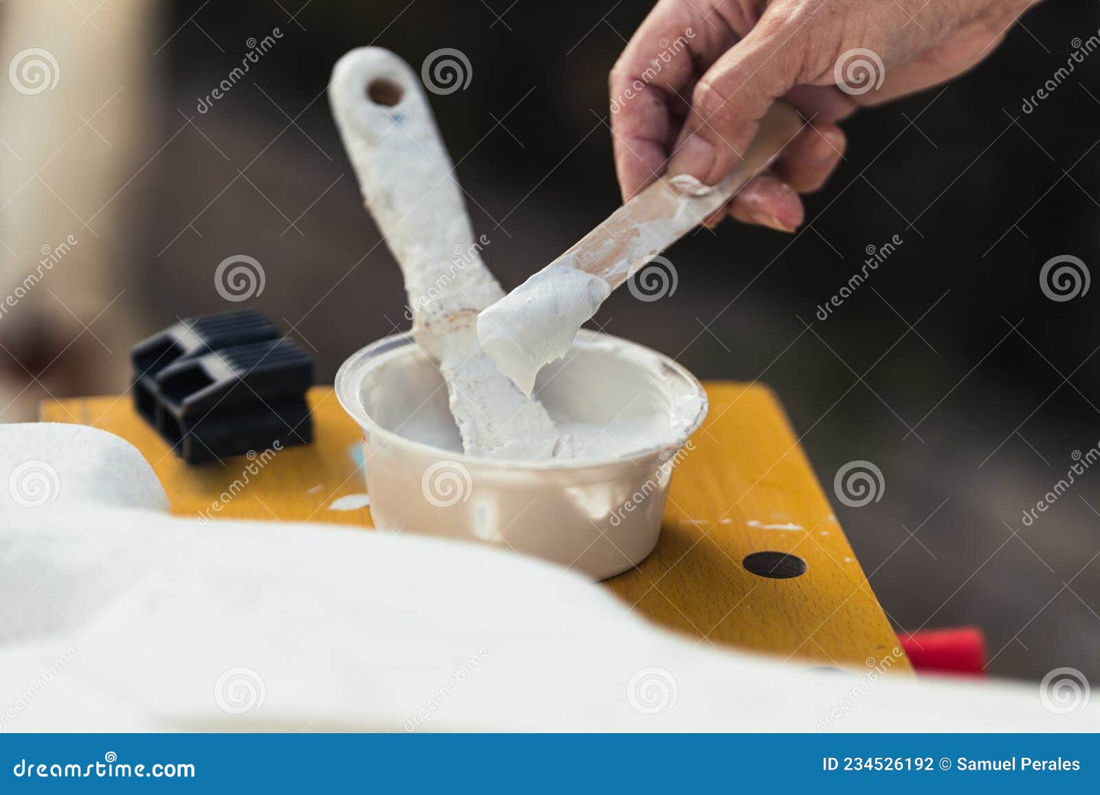 Person Dipping White Paste with a Spatula in a Workshop Stock Photo ...