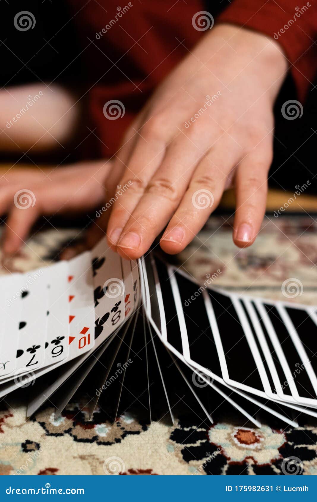 A Person Doing a Ribbon Spread with His Playing Cards Stock Image ...