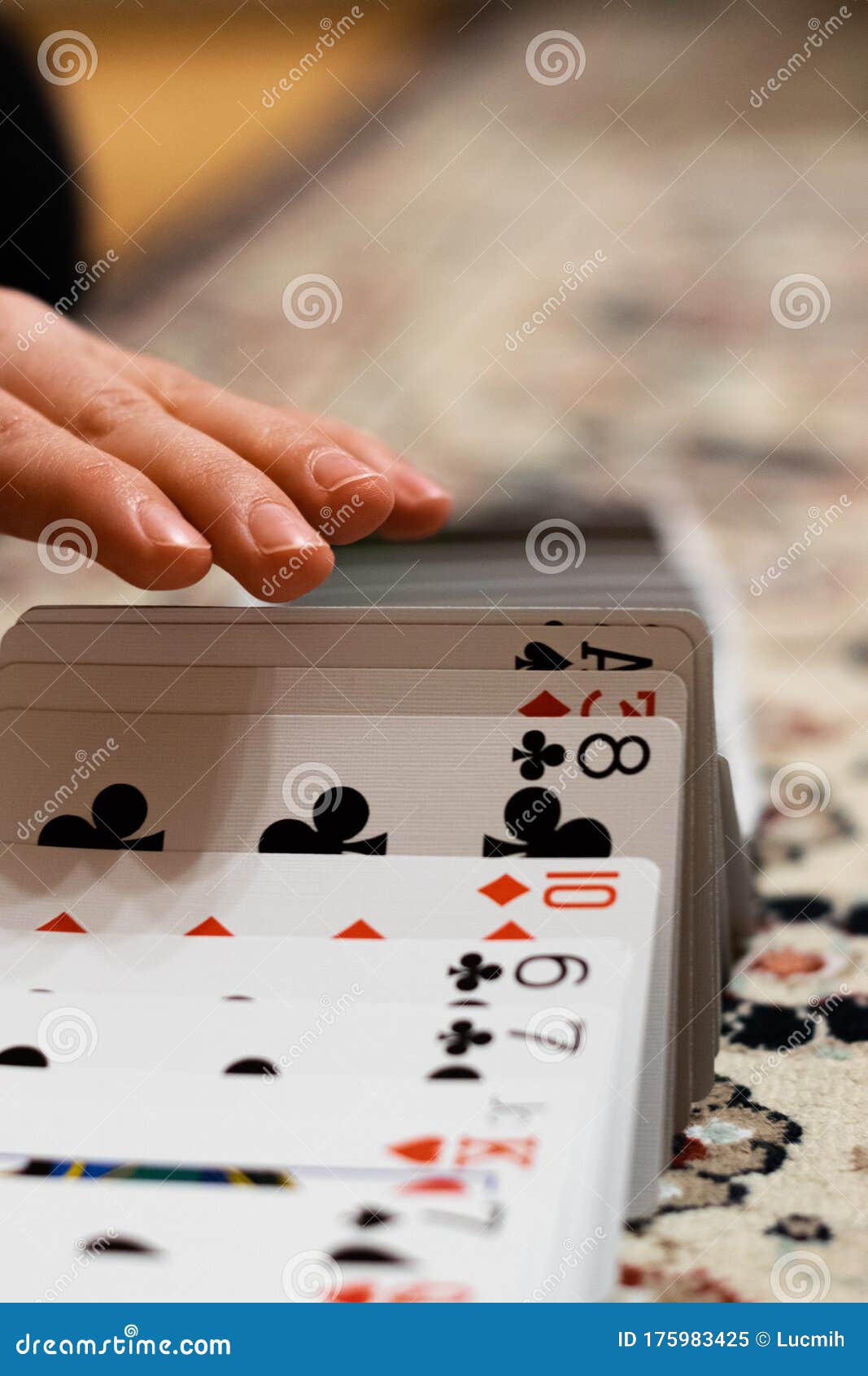 A Person Doing a Ribbon Spread with His Playing Cards Stock Image ...