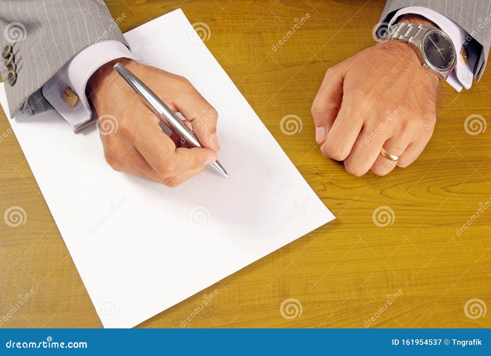 Person Dressed in Suit Writing on Paper at Table Stock Image - Image of ...