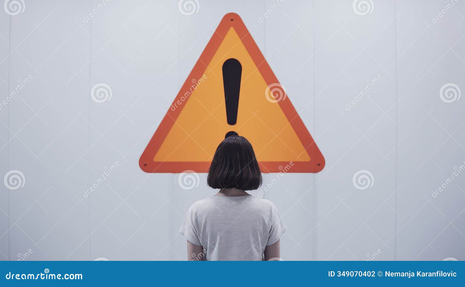 Person Facing Large Hazard Sign with Exclamation Mark in Center Stock ...