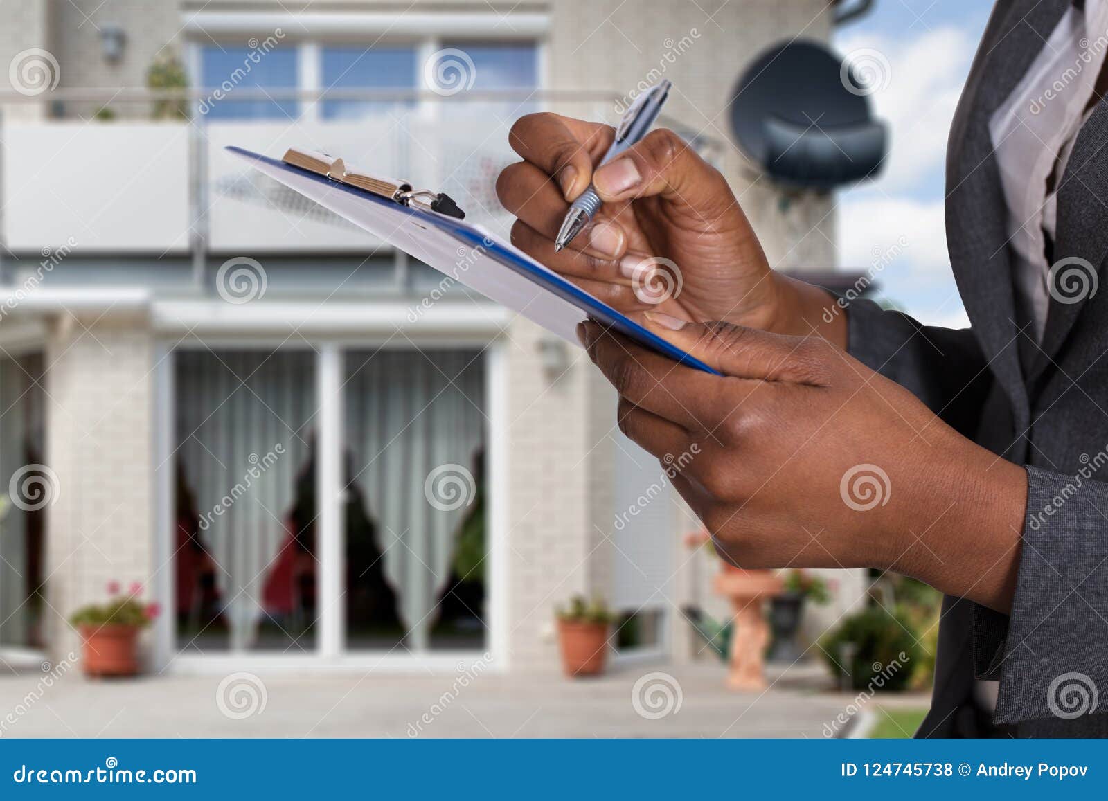 Person Filling Document in Front of House Stock Photo - Image of ...
