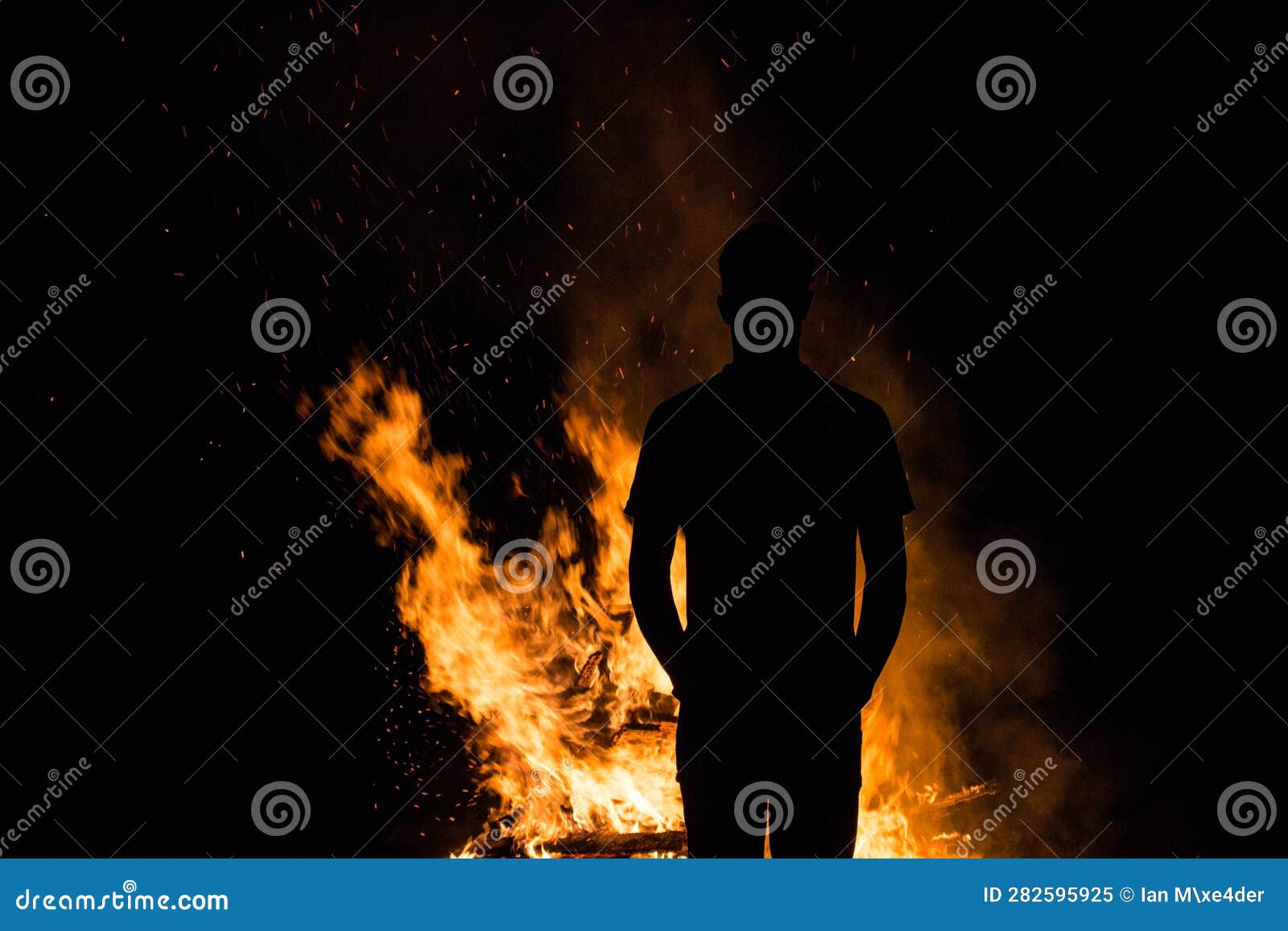 Person before a fire. stock image. Image of orange, dark - 282595925