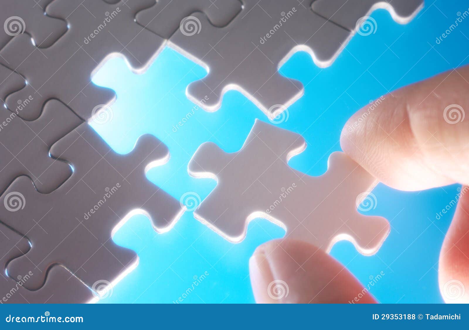 A Person Fitting Puzzle Pieces on Blue Background. Stock Photo - Image ...