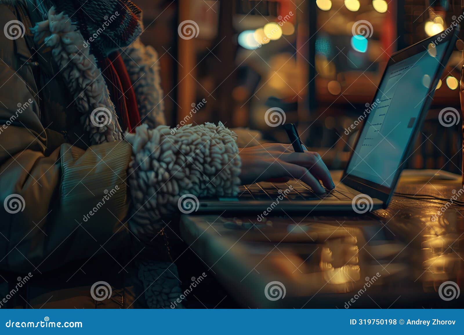 A Person Focused on Typing on a Laptop Computer while Seated at a Table ...