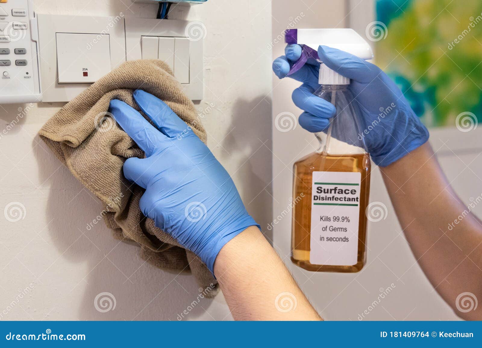 Person in Gloves Disinfecting Light Switch Panel Surface with ...